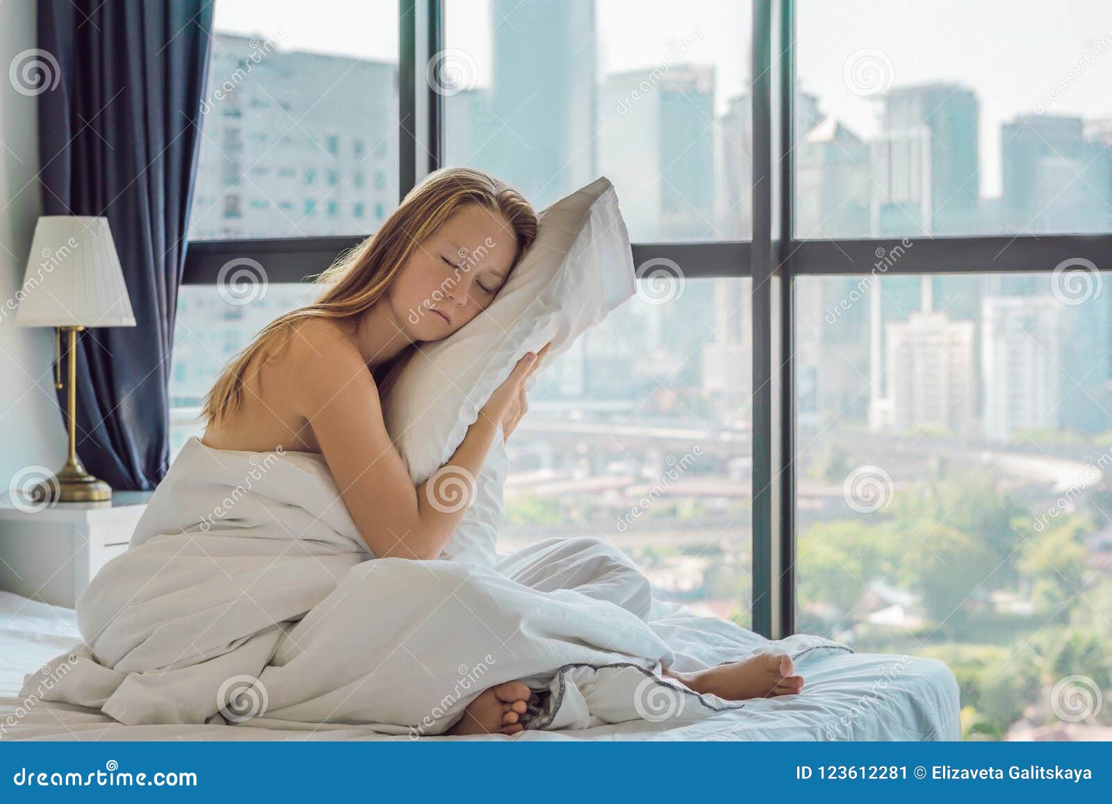 Woman Wakes Up in the Morning in an Apartment in the Downtown Ar Stock ... Woman Wakes Up in the Morning in an Apartment in the Downtown Ar Stock ...
