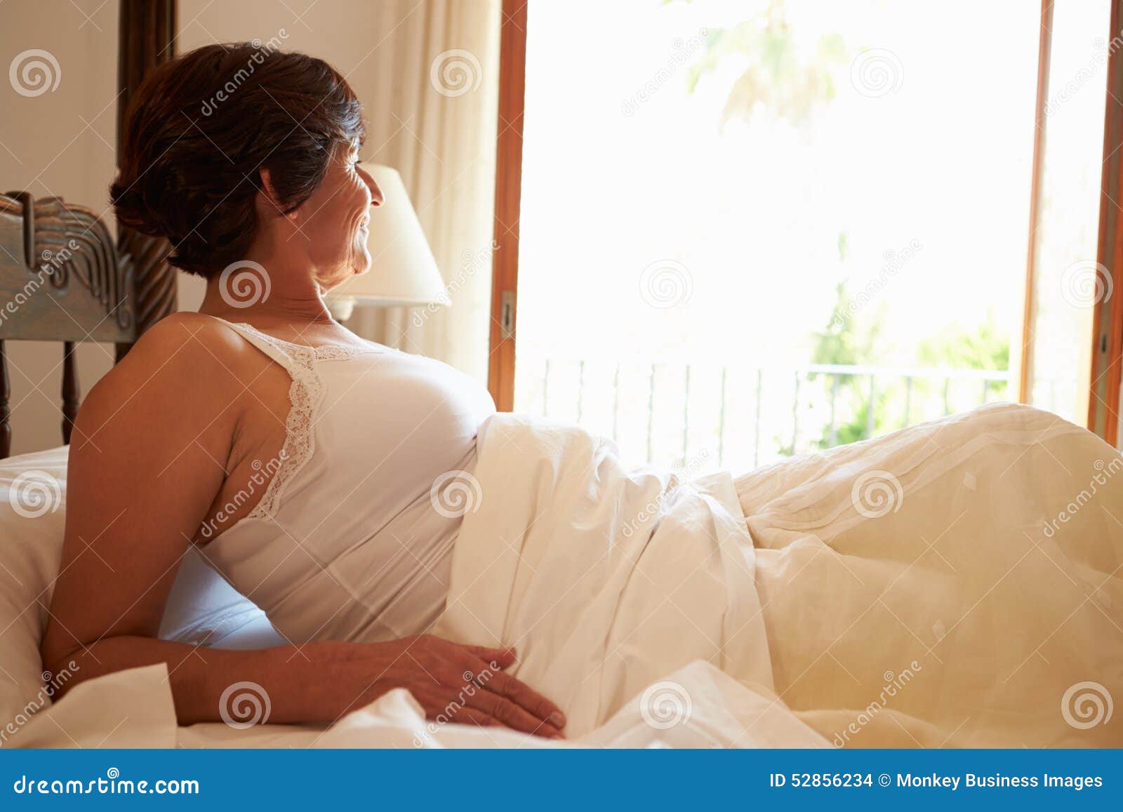 Woman Waking Up in Bed in Morning Stock Photo - Image of kissing, face ...