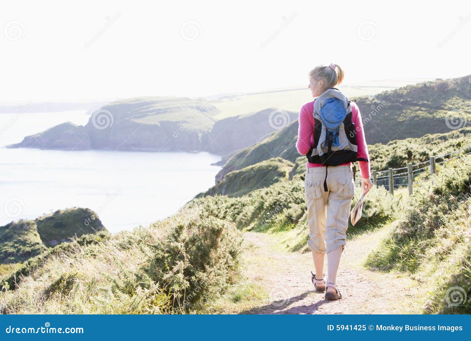 Woman Walking on Cliffside Path Stock Image - Image of hiking ...