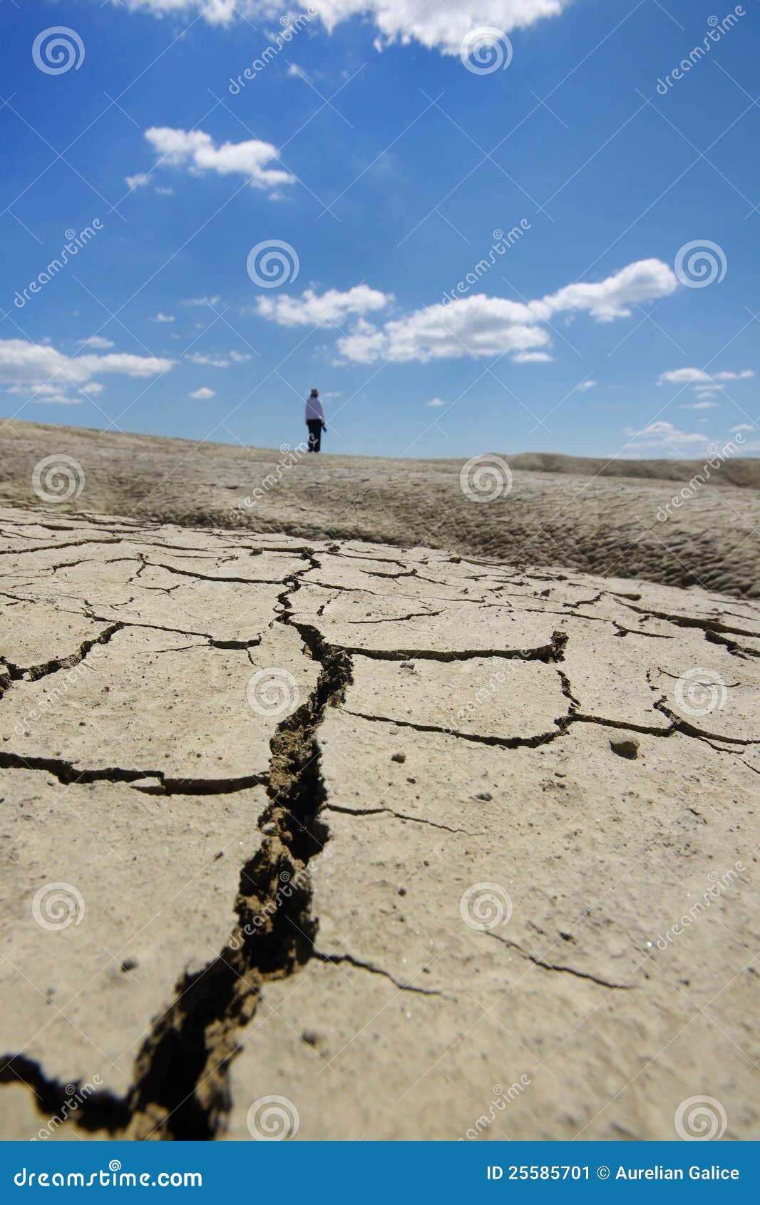 Woman Walking on Desolate Cracked Earth Landscape Stock Image - Image ...