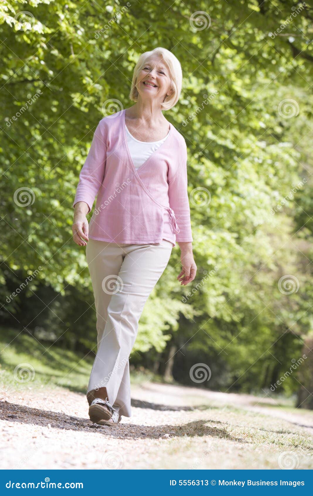 Woman Walking Outdoors Smiling Stock Image - Image of active, happy ...