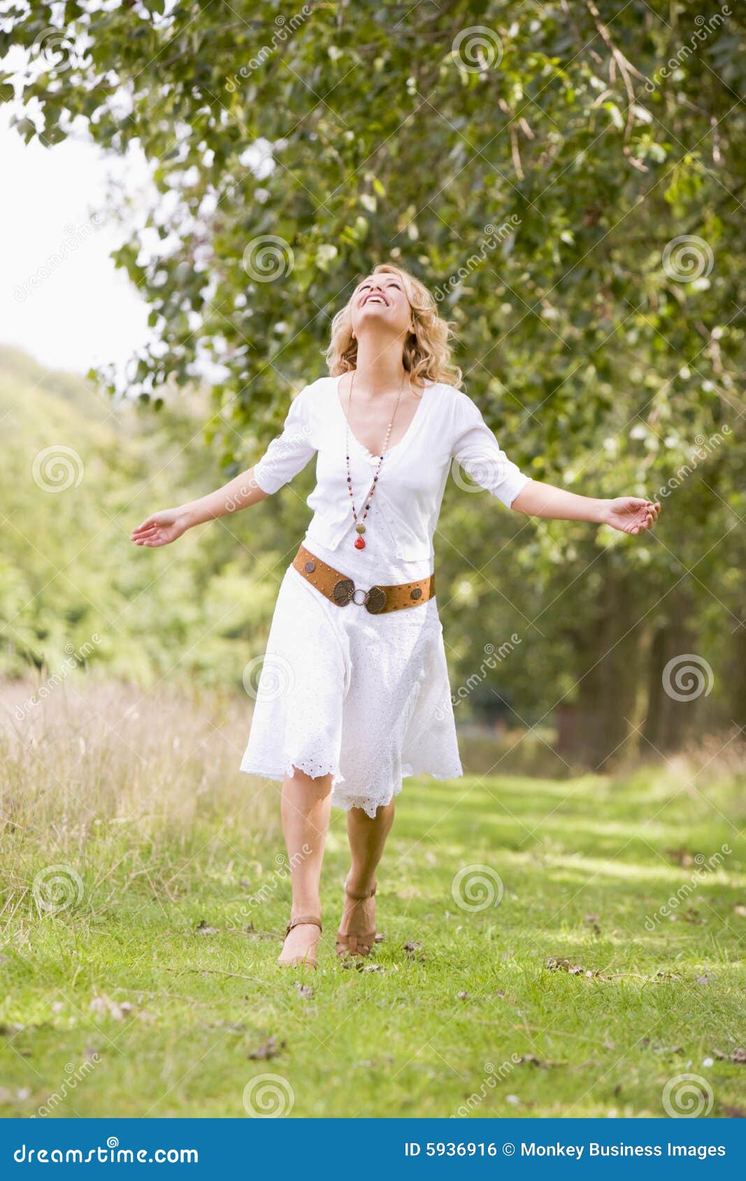 Woman Walking on Path Smiling Stock Photo - Image of vitality, length ...