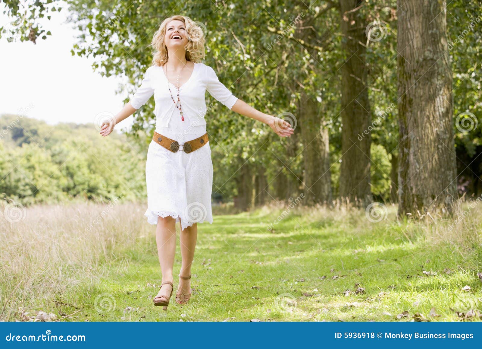 Woman Walking on Path Smiling Stock Photo - Image of wife, twenties ...