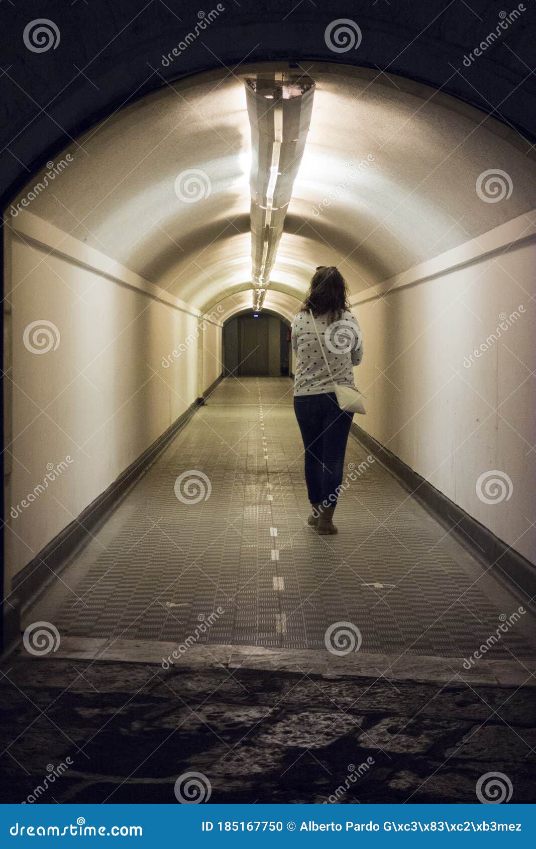 Woman Walking through an Underground Tunnel Stock Photo - Image of ...