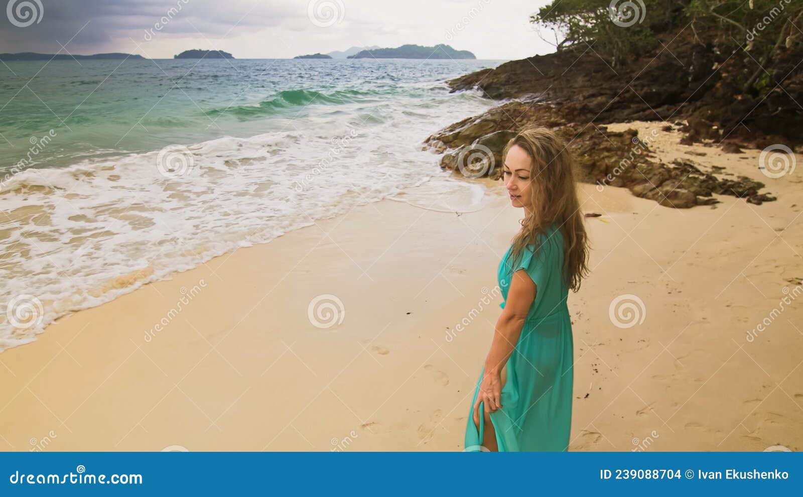 Woman Walks To The Stormy Cloudy Ocean On Sand Beach Girl In Blue