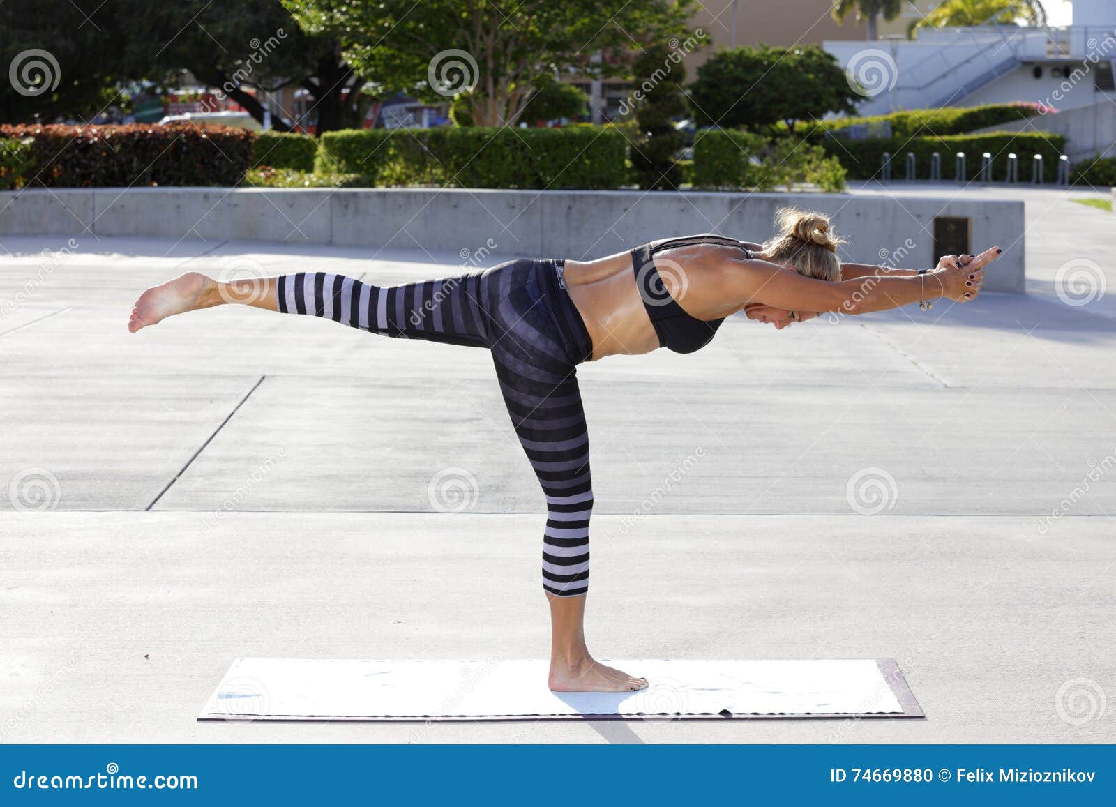 Woman in a warrior pose stock photo. Image of smile, yoga - 74669880