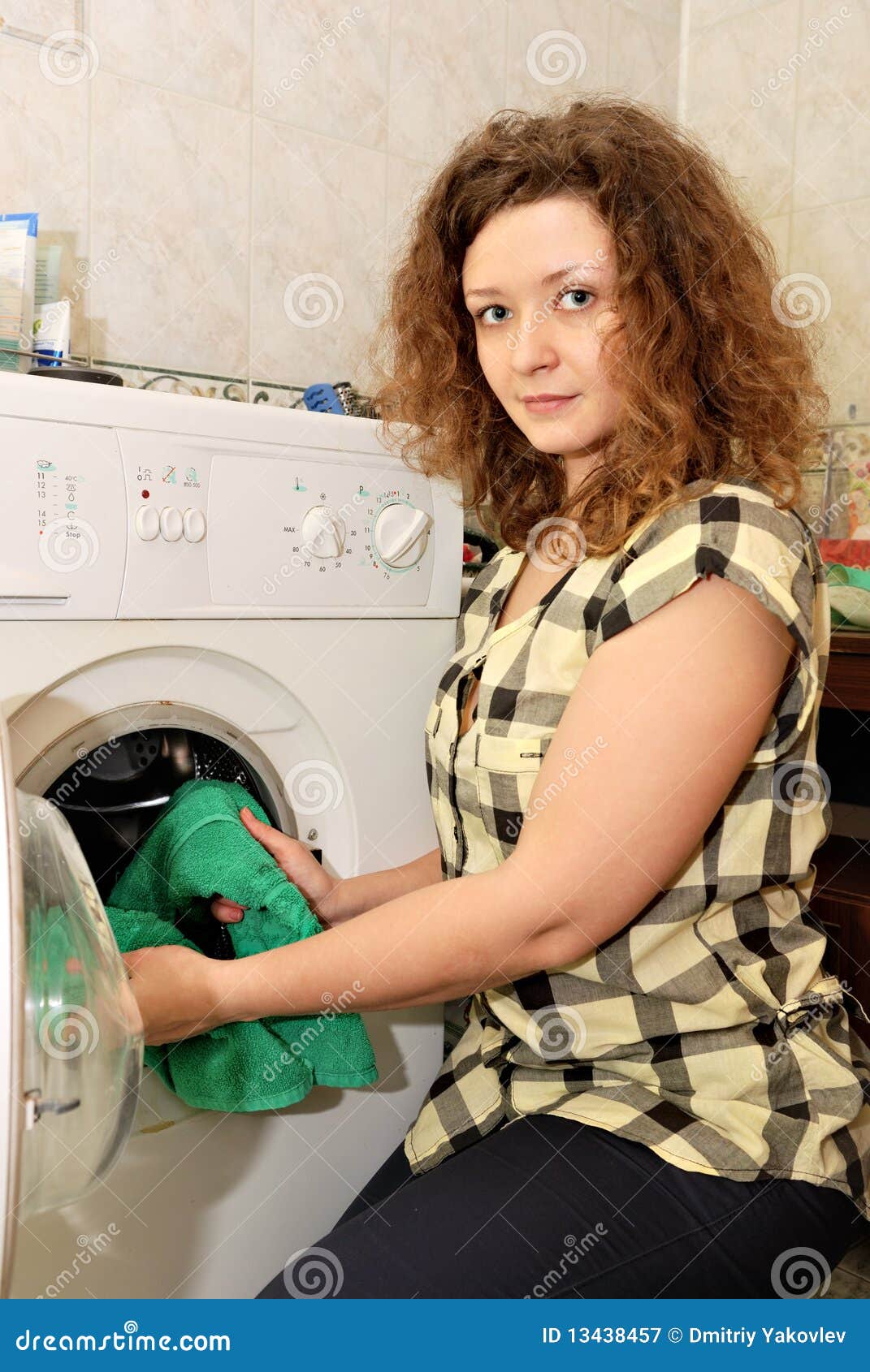 Woman with washing machine stock image. Image of camera - 13438457