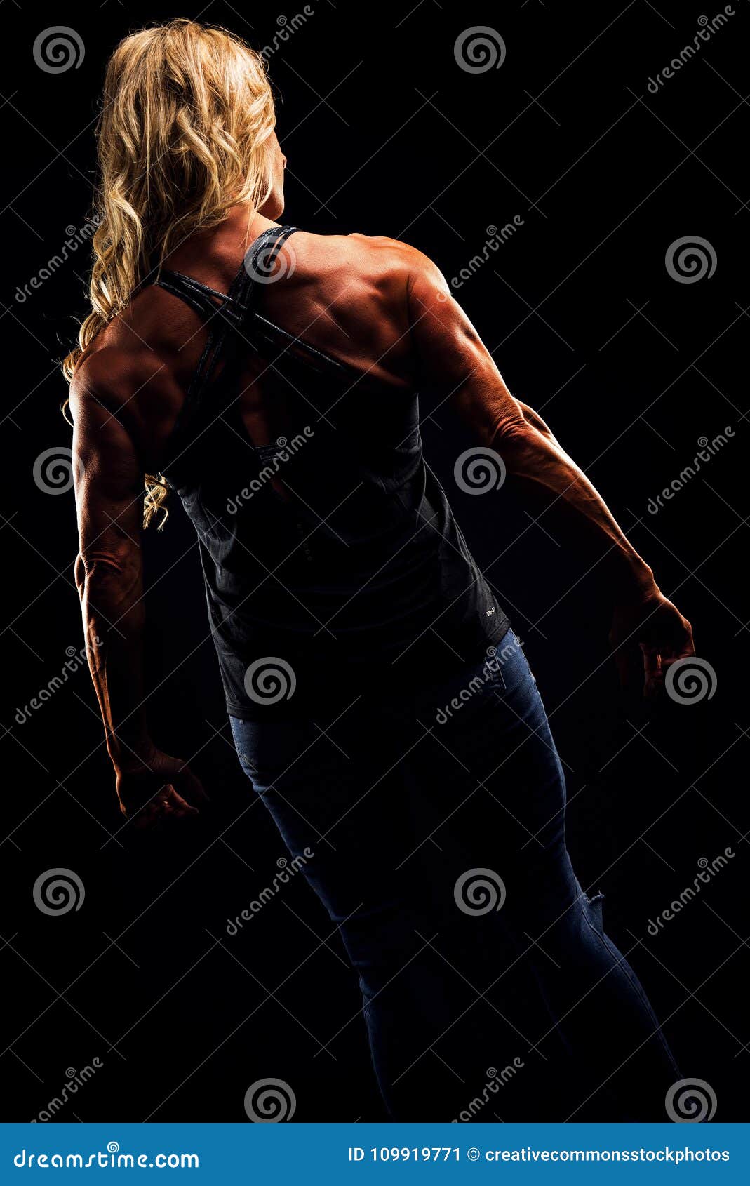 Woman Wearing Criss Cross Back Strap Top Flexing Picture. Image: 109919771