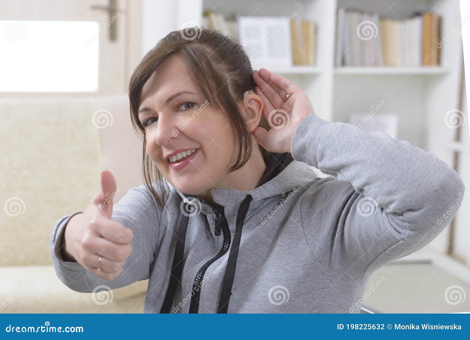 Woman wearing deaf aid stock photo. Image of audiology - 198225632