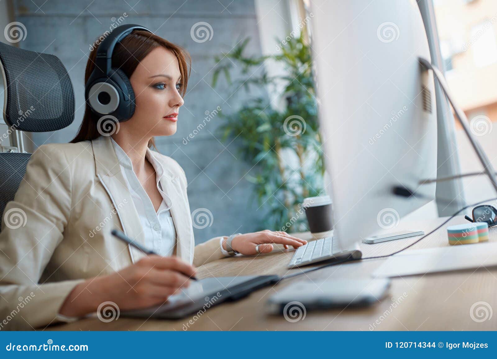 Woman Wearing Headphones and Working in Design Studio Stock Photo ...