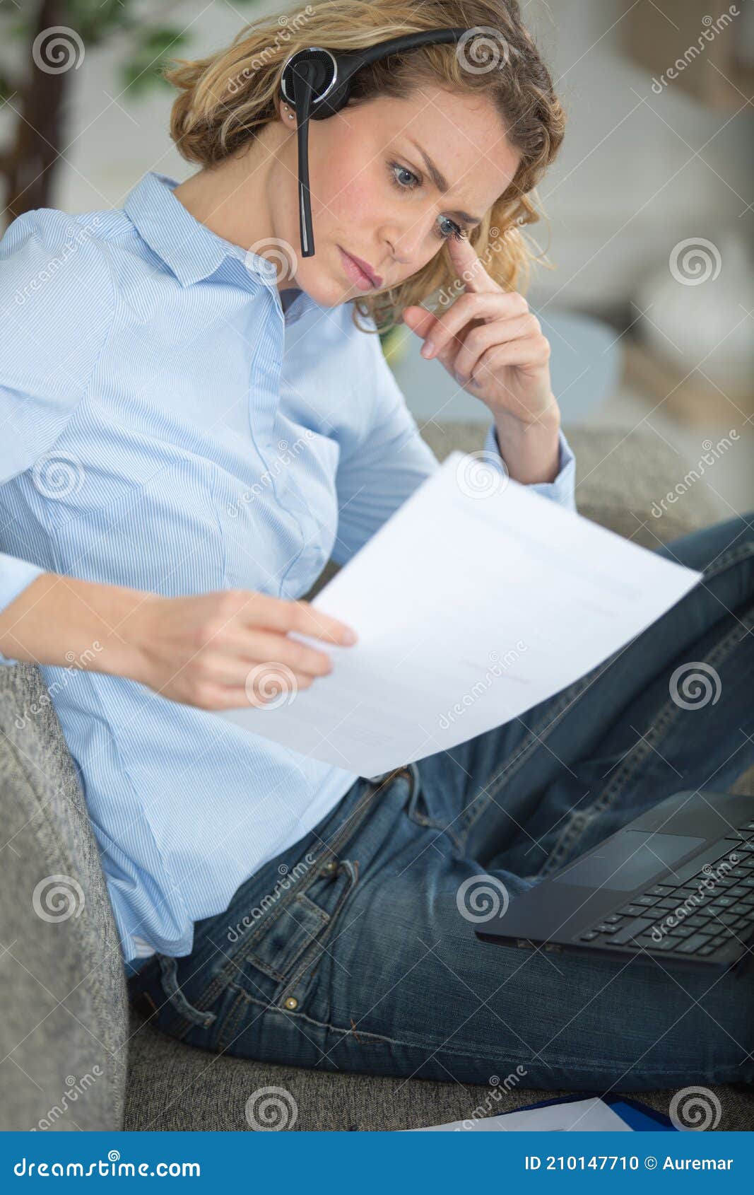 Woman Wearing Headset Reading Paperwork Stock Photo - Image of ...