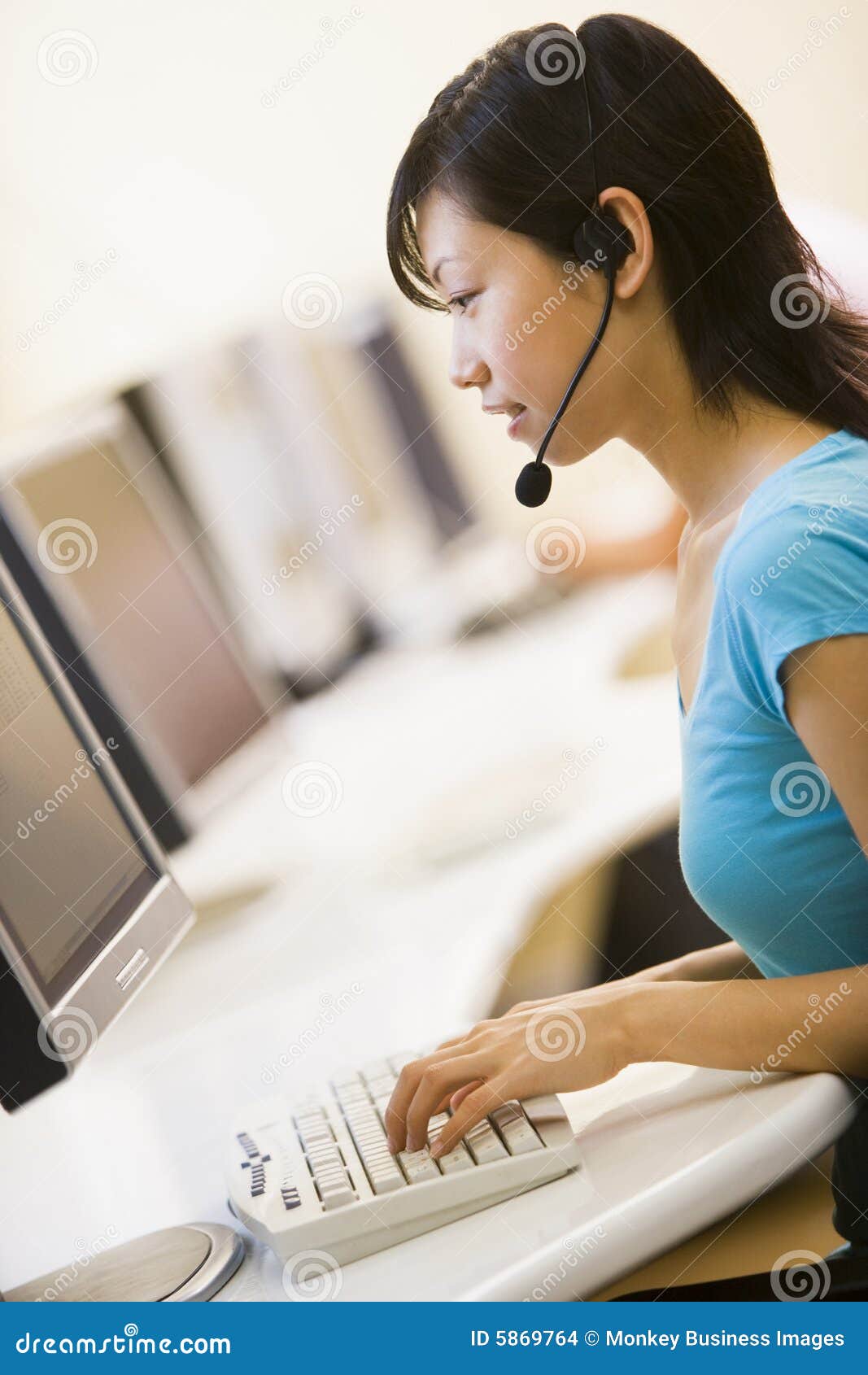 Woman Wearing Headset Sitting in Computer Room Stock Photo - Image of ...