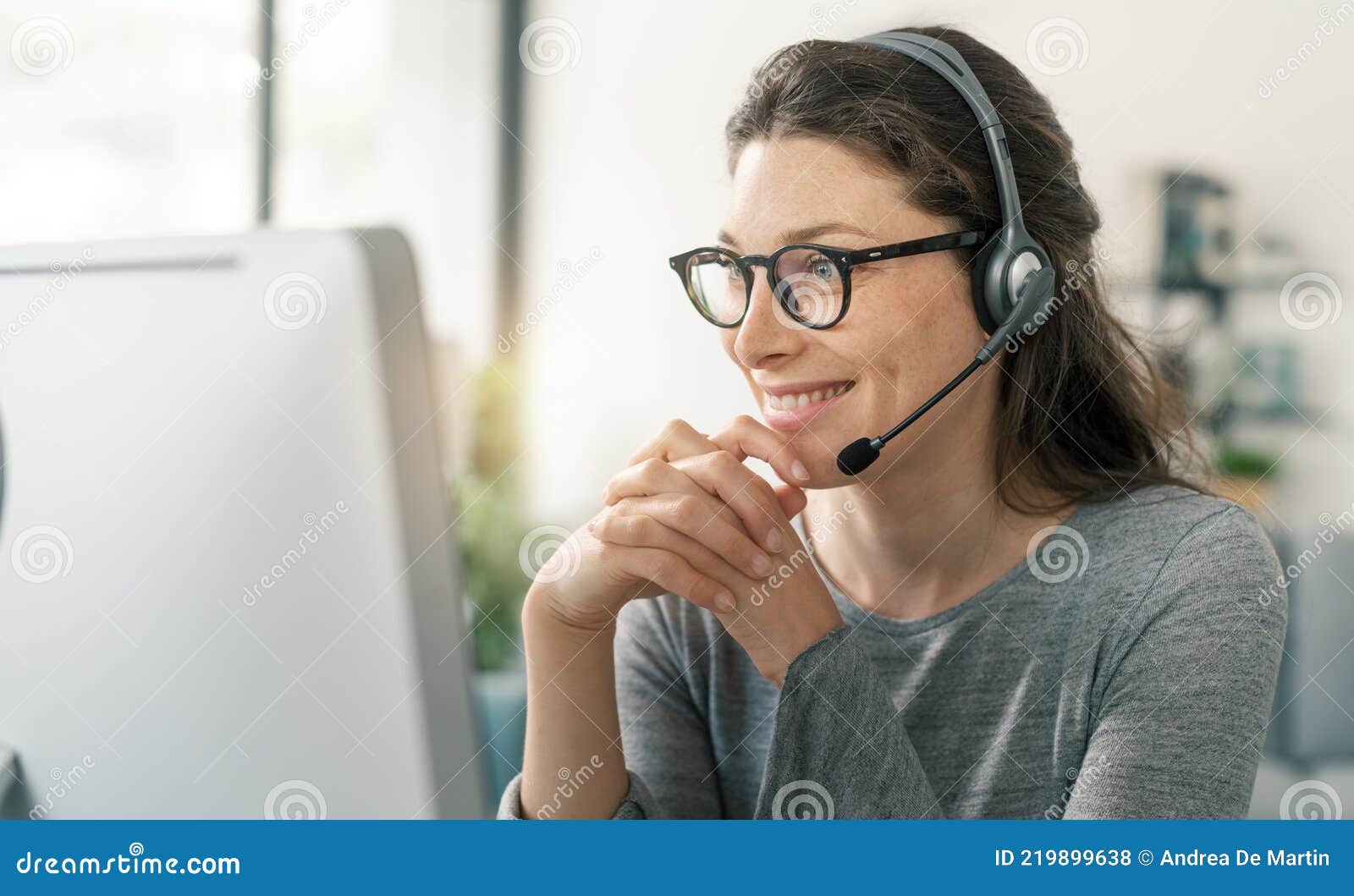 Woman Wearing a Headset and Working with Her Computer Stock Photo ...
