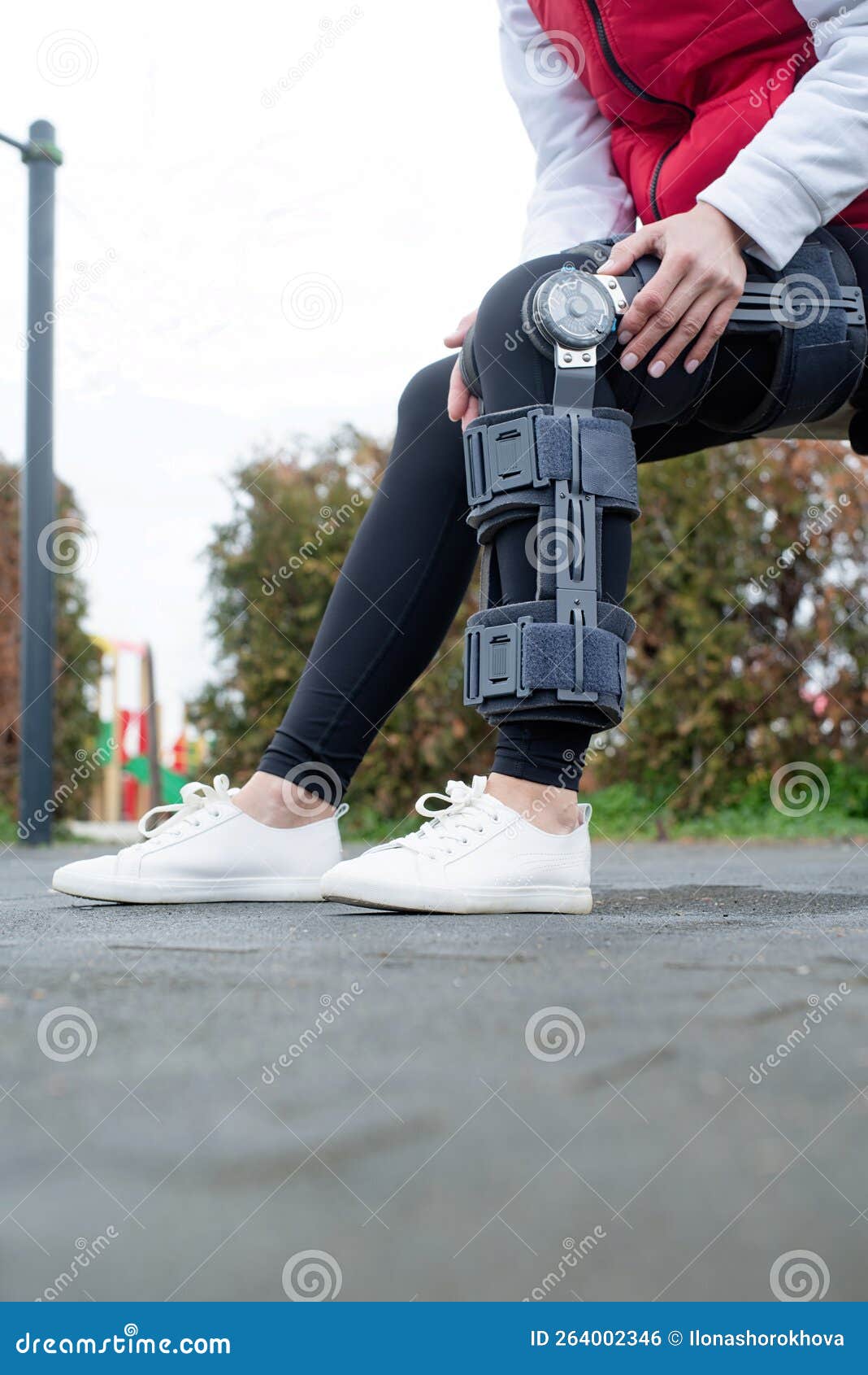 Woman Wearing Knee Brace Or Orthosis After Leg Surgery Working Out In