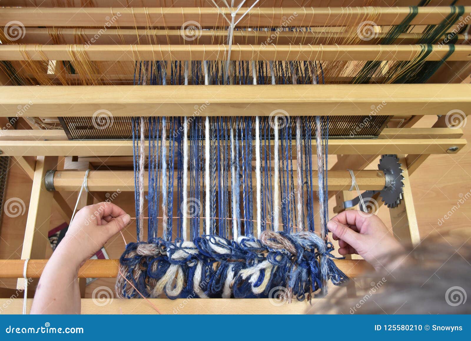 Woman weaving on a loom stock photo. Image of color - 125580210