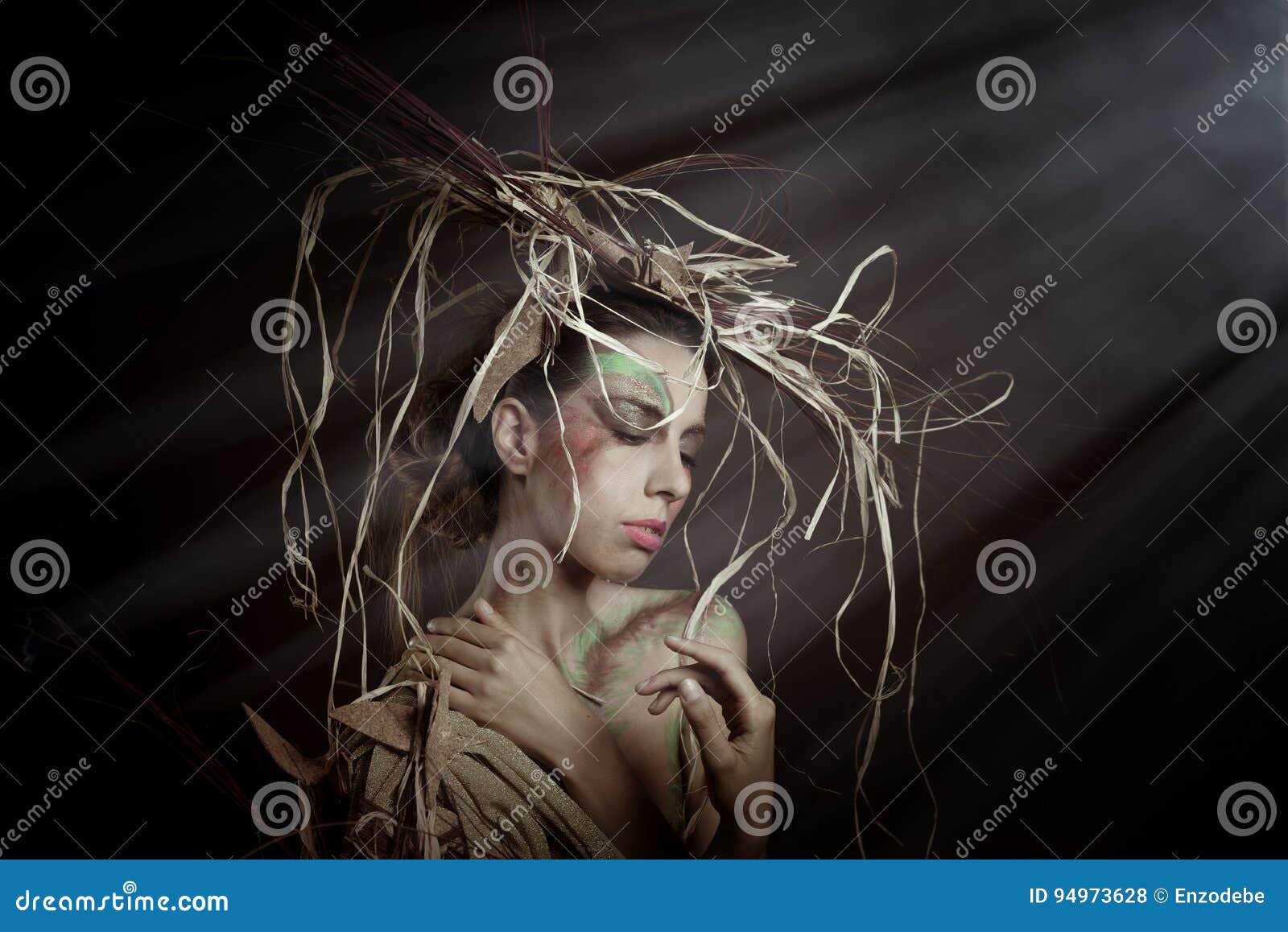 Woman With Wild Look Posing With Colorful Makeup In Fantasy Atmosphere