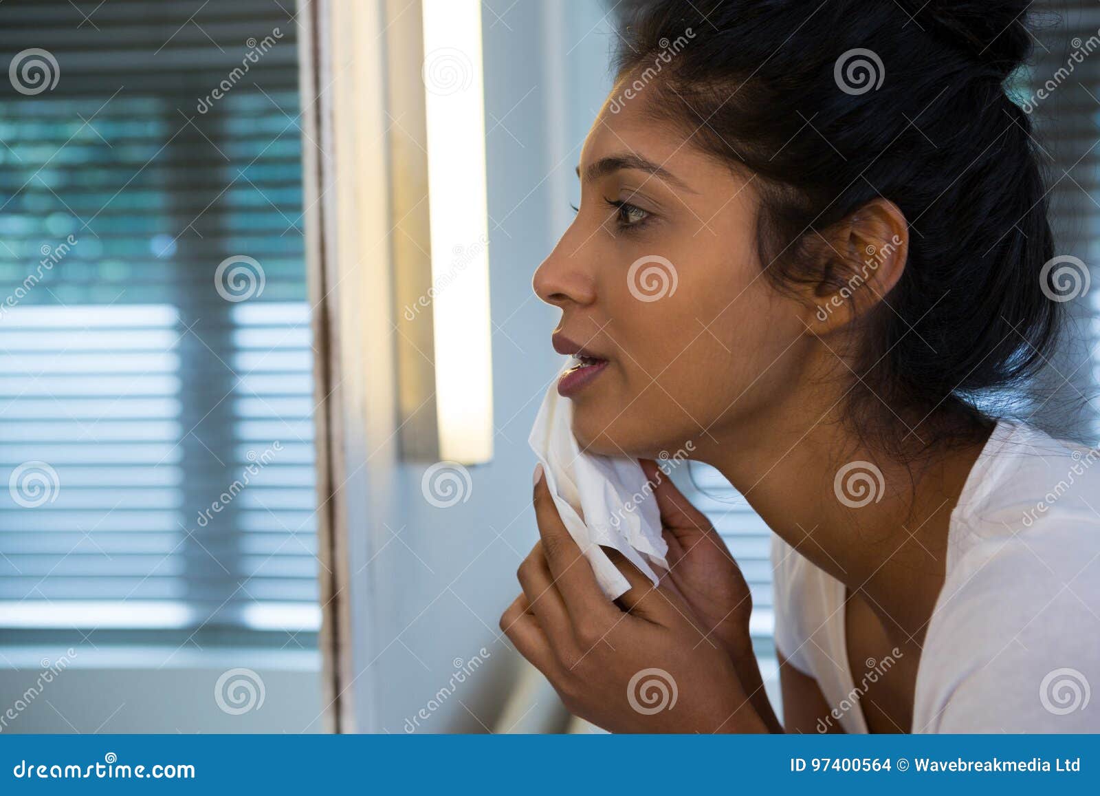 Woman Wiping Face in Bathroom Stock Photo - Image of life, hair: 97400564