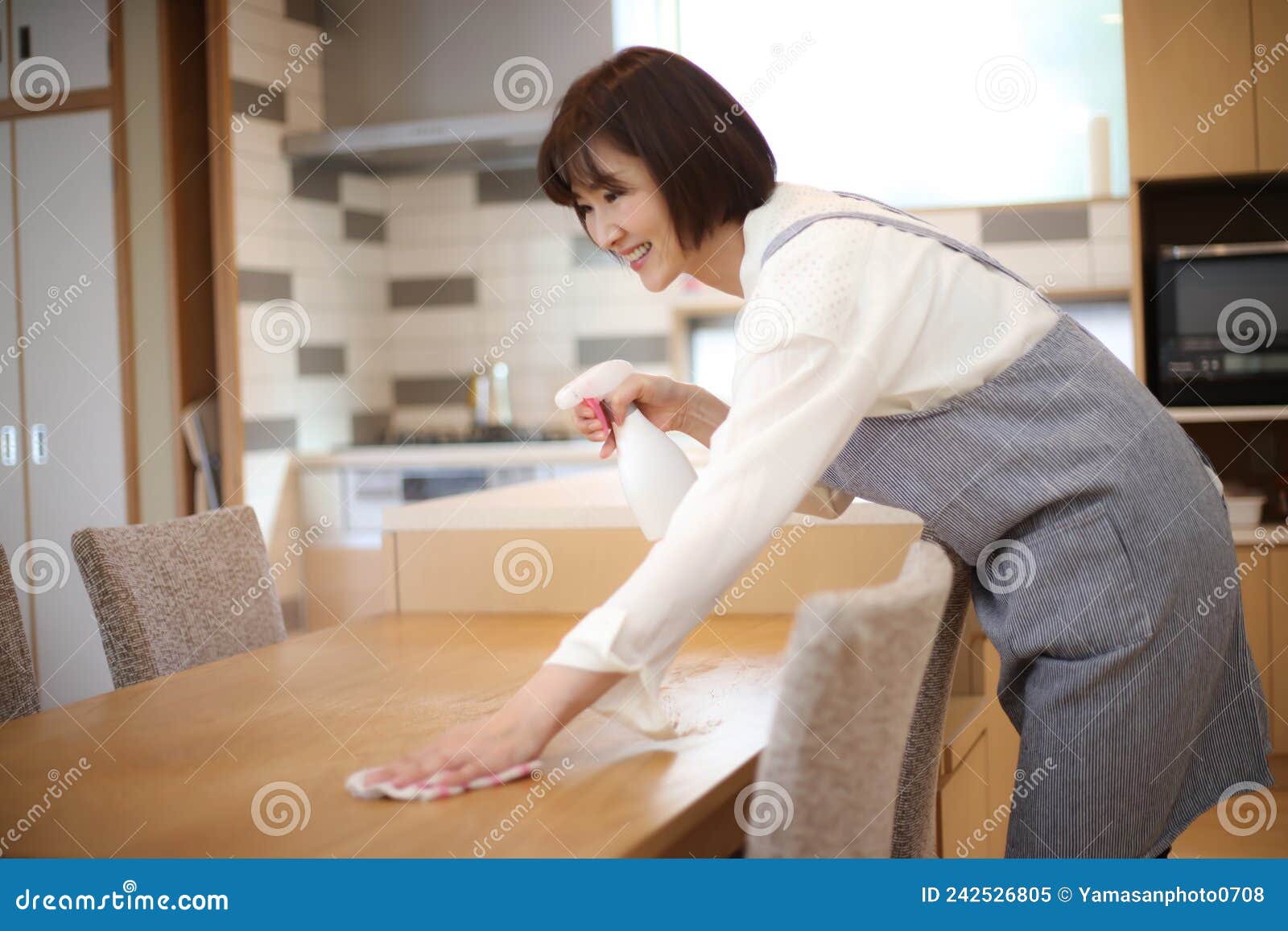 Woman wiping the table stock image. Image of person - 242526805