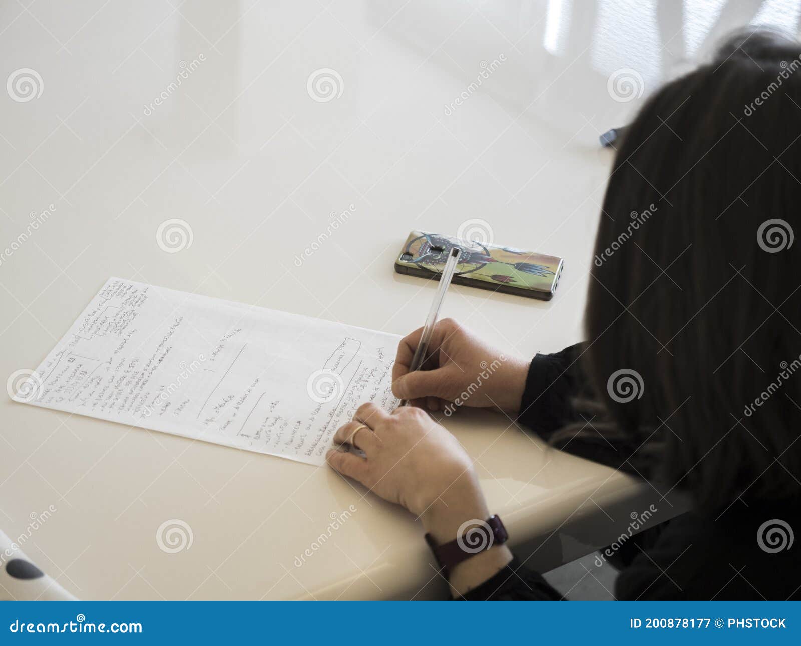 Woman at work taking notes stock image. Image of person - 200878177
