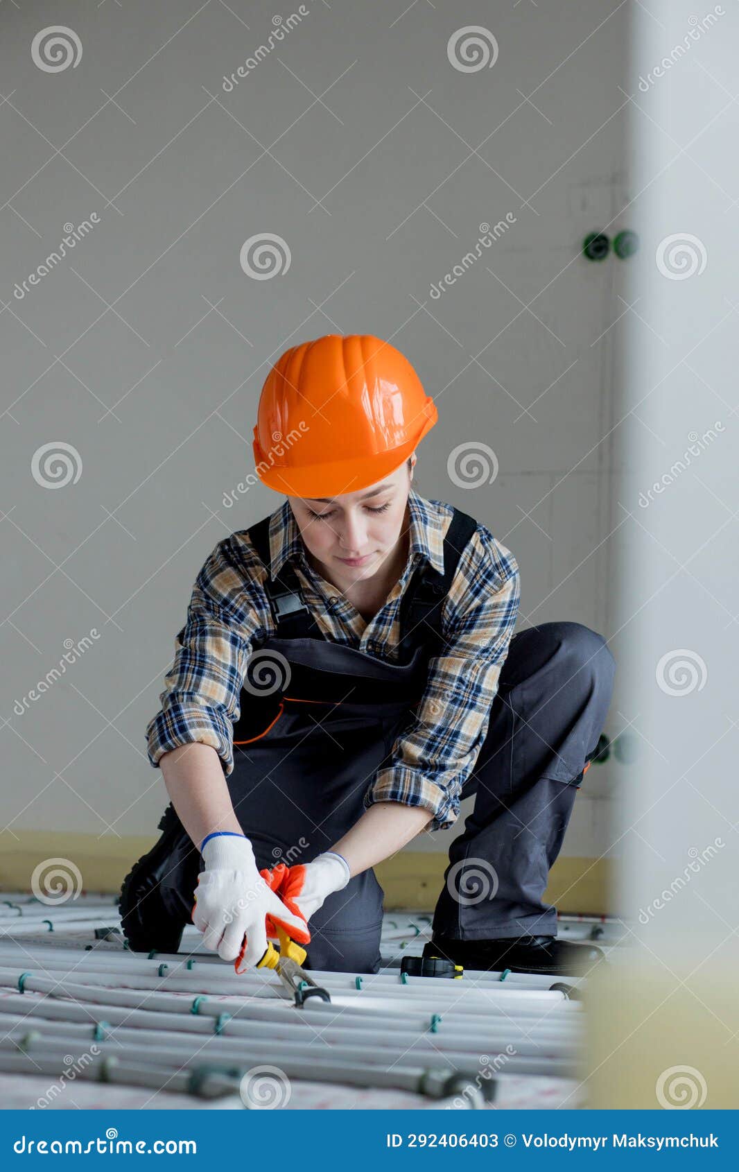 Woman Worker is Installing Underfloor Heating System. Warm Floor ...