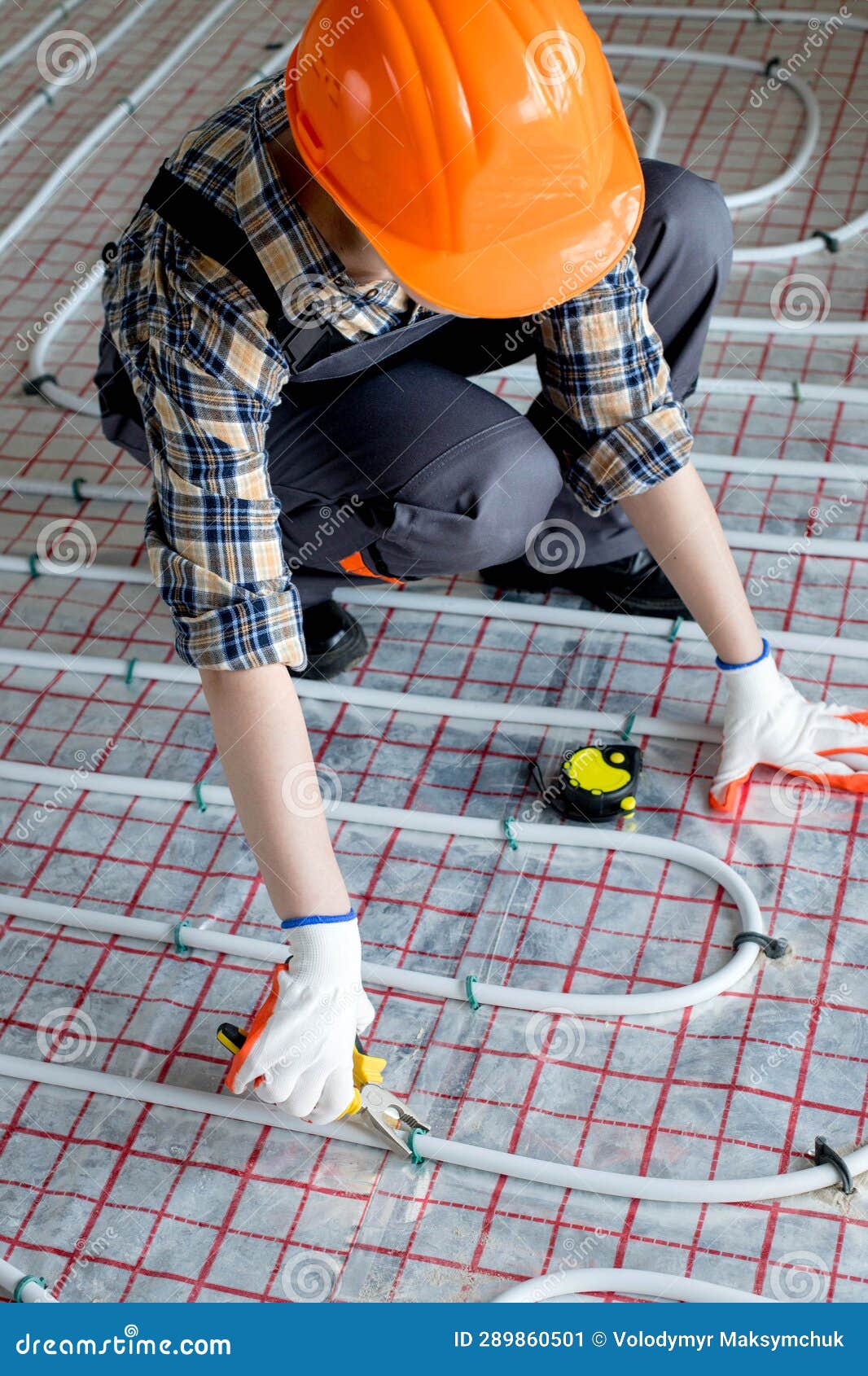 Woman Worker is Installing Underfloor Heating System. Warm Floor ...
