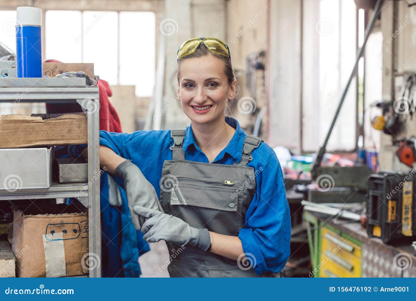 Woman Worker In A Helmet Against The Backdrop Of Hydroelectric Turbines ...