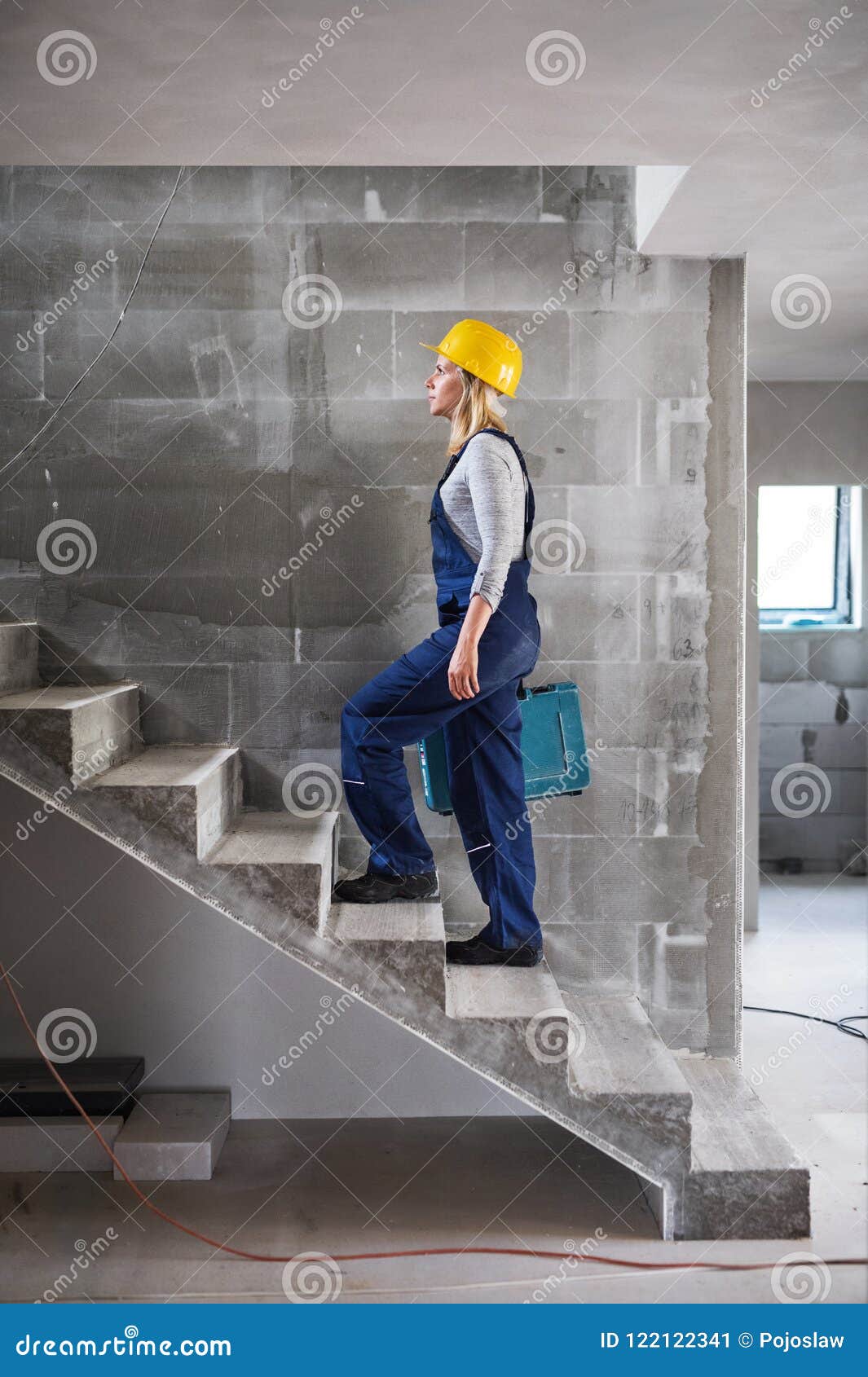 Woman Worker with a Tool Box Walking Up the Stairs on the Construction ...