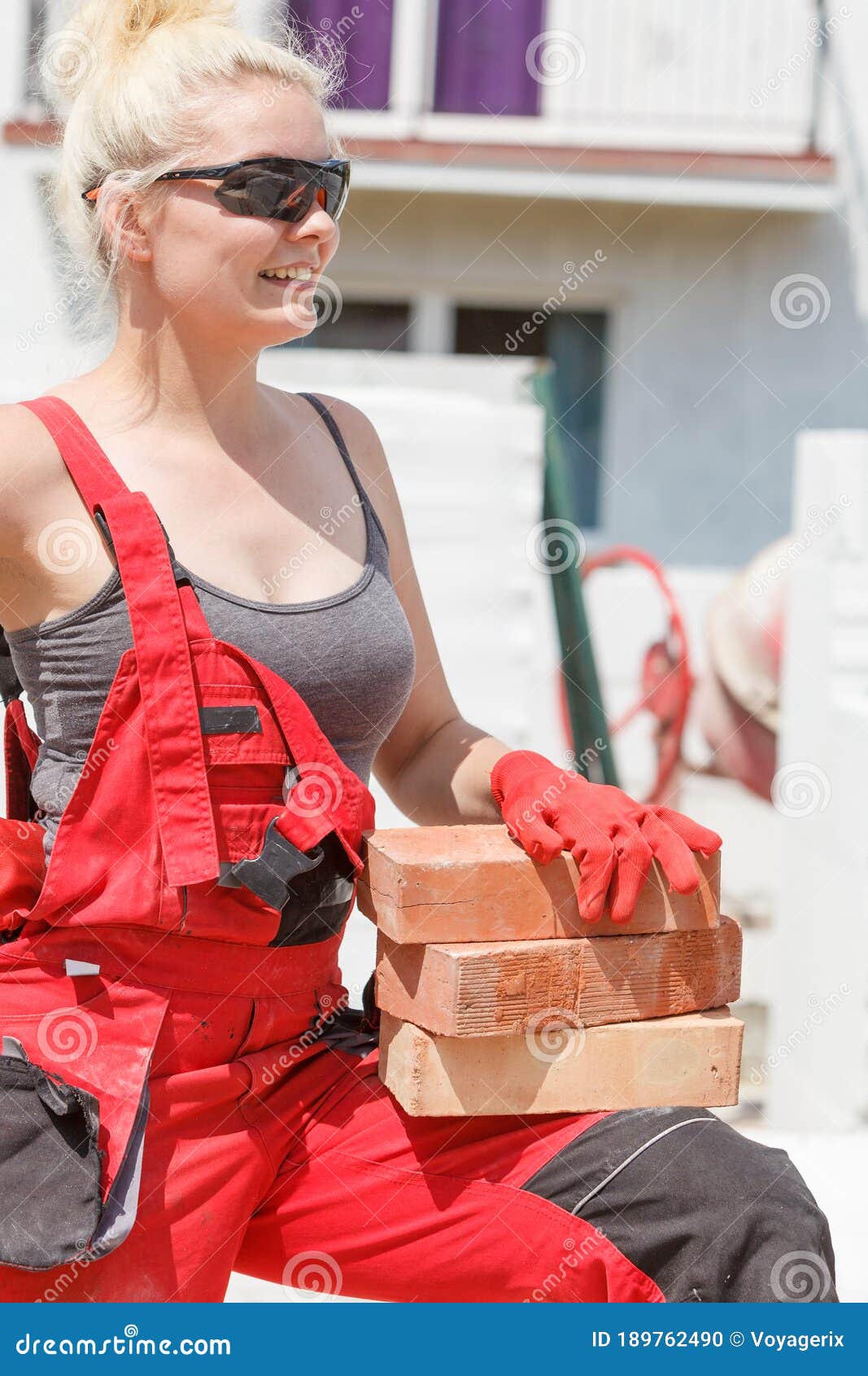 Woman working with bricks stock photo. Image of house - 189762490
