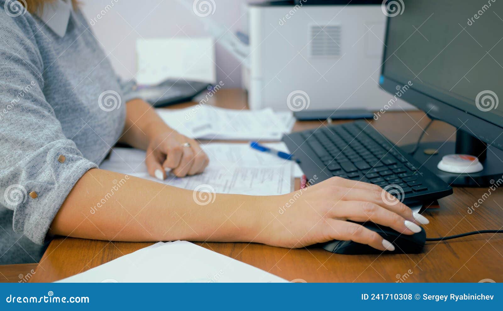 Woman Working on Computer in Office. Scrolling through a Spreadsheets ...