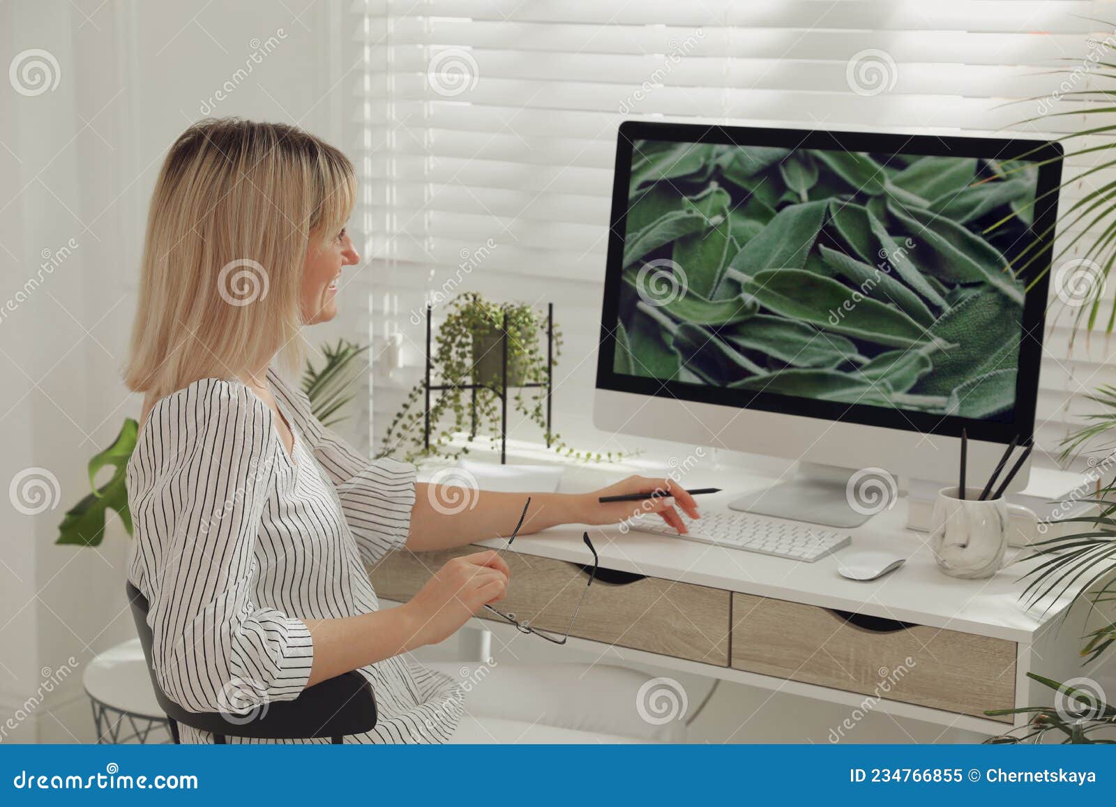 Woman Working on Computer at Table in Room. Interior Design Stock Image ...