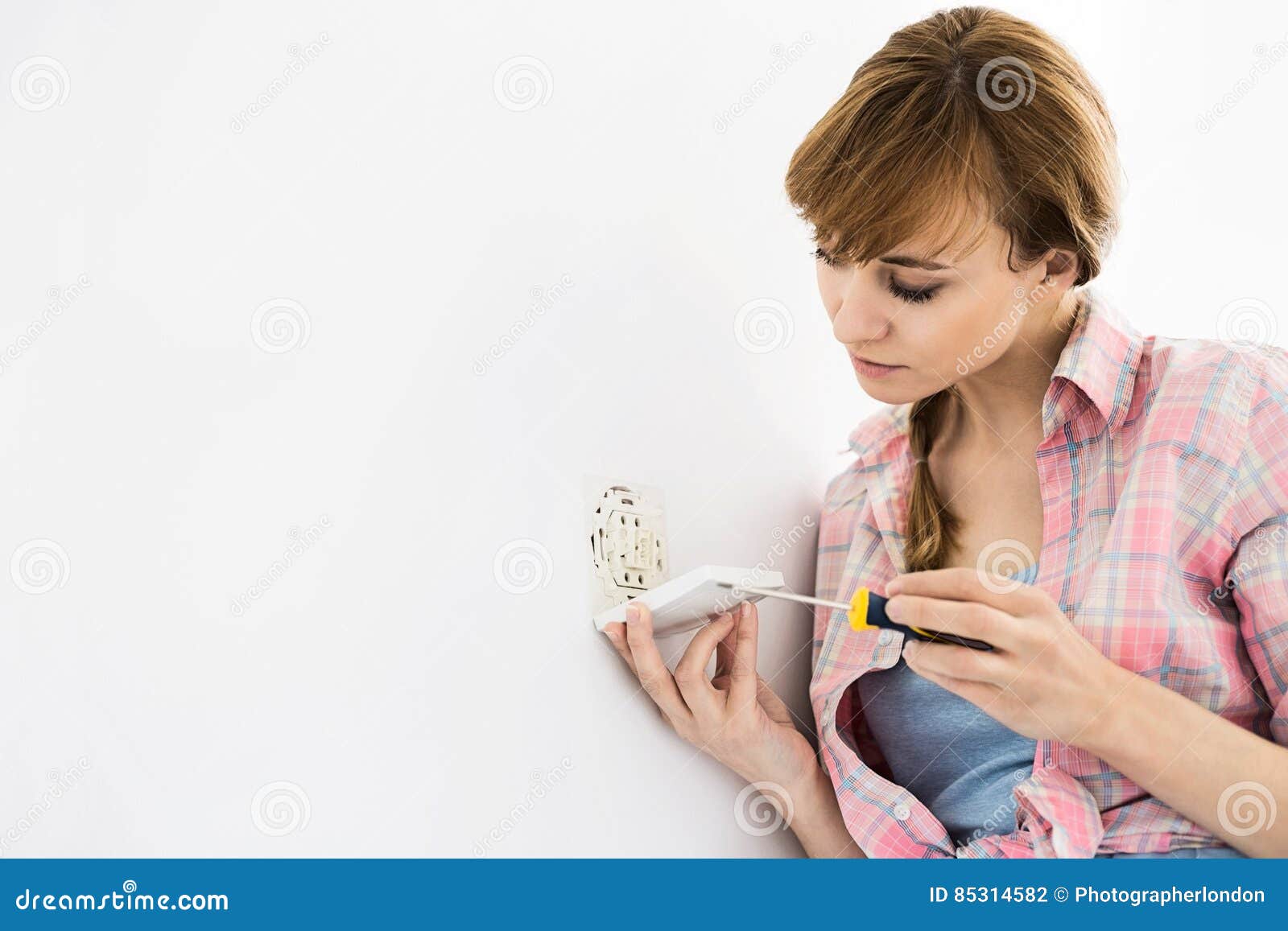 Woman Working on Electrical Outlet Stock Photo - Image of female ...