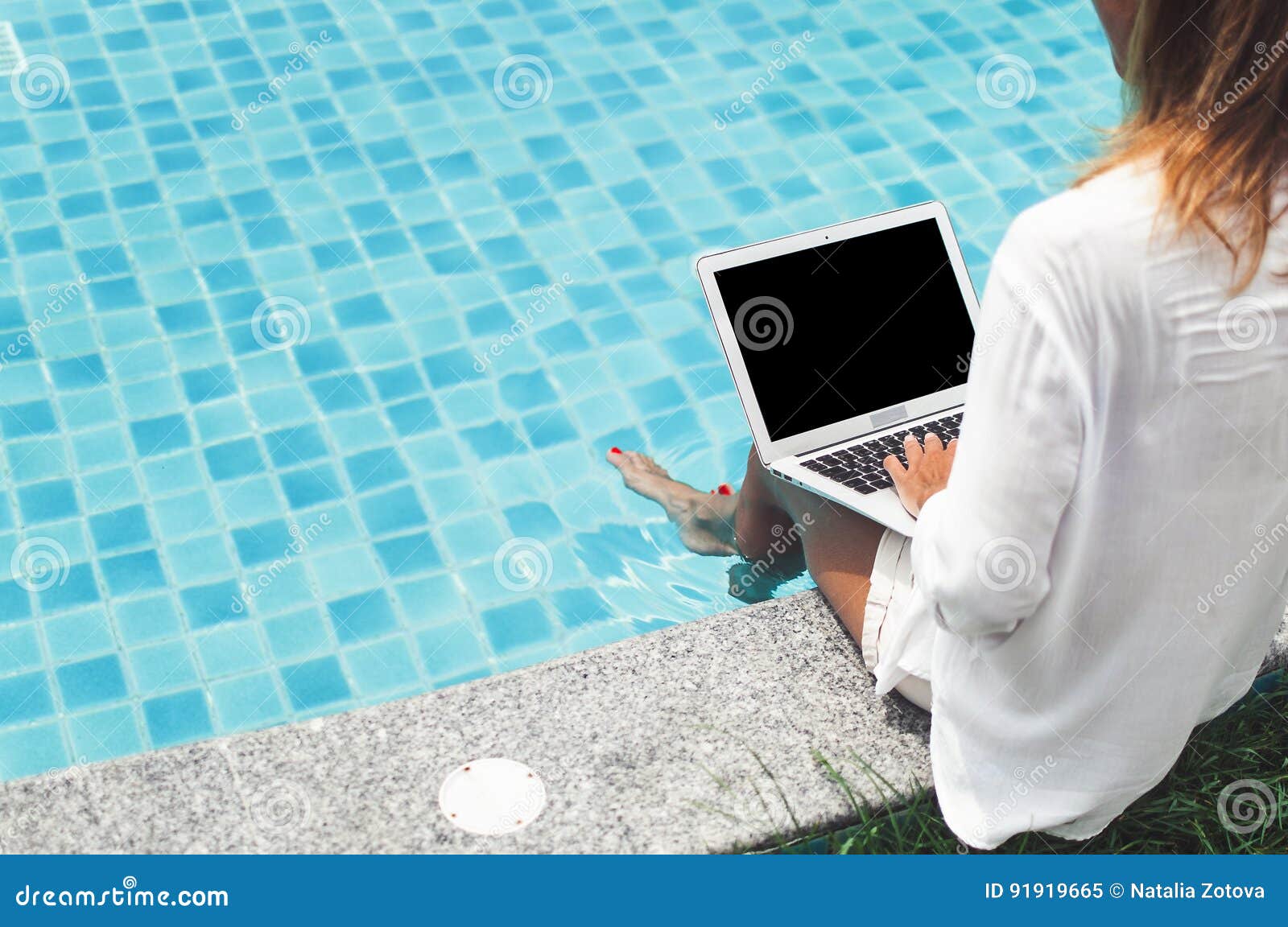 Woman Working on Her Laptop Computer Sitting at Poolside Stock Image ...