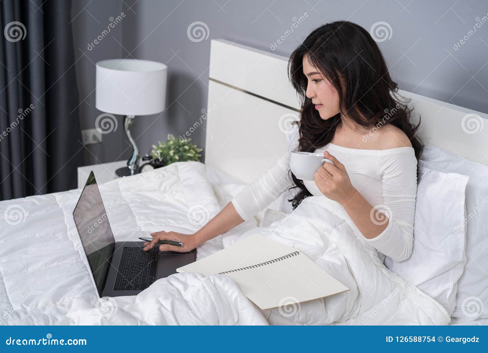 Woman Working with Laptop Computer on Bed Stock Photo - Image of ...