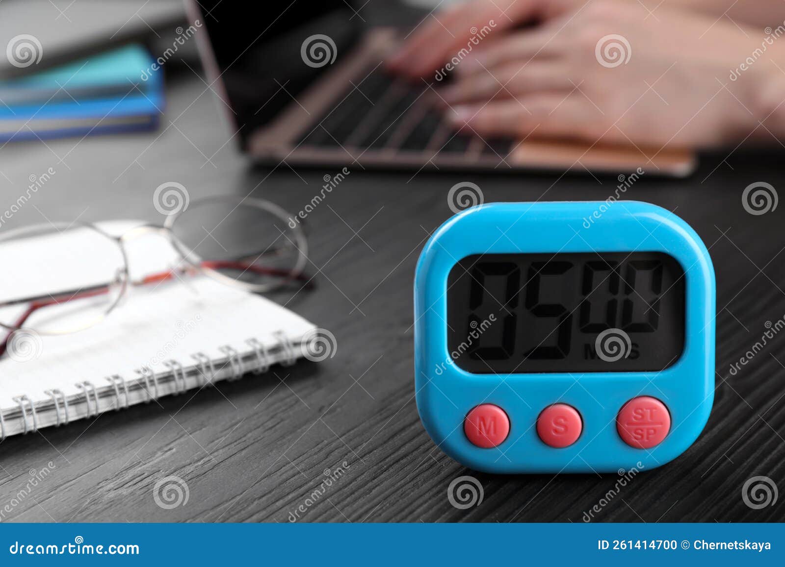 Woman Working on Laptop at Wooden Table, Focus on Kitchen Timer. Space ...
