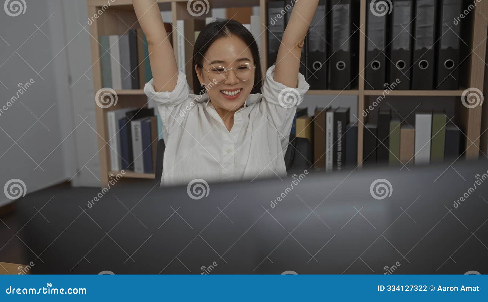 Woman Working in Office Feeling Victorious while Raising Arms in Front ...