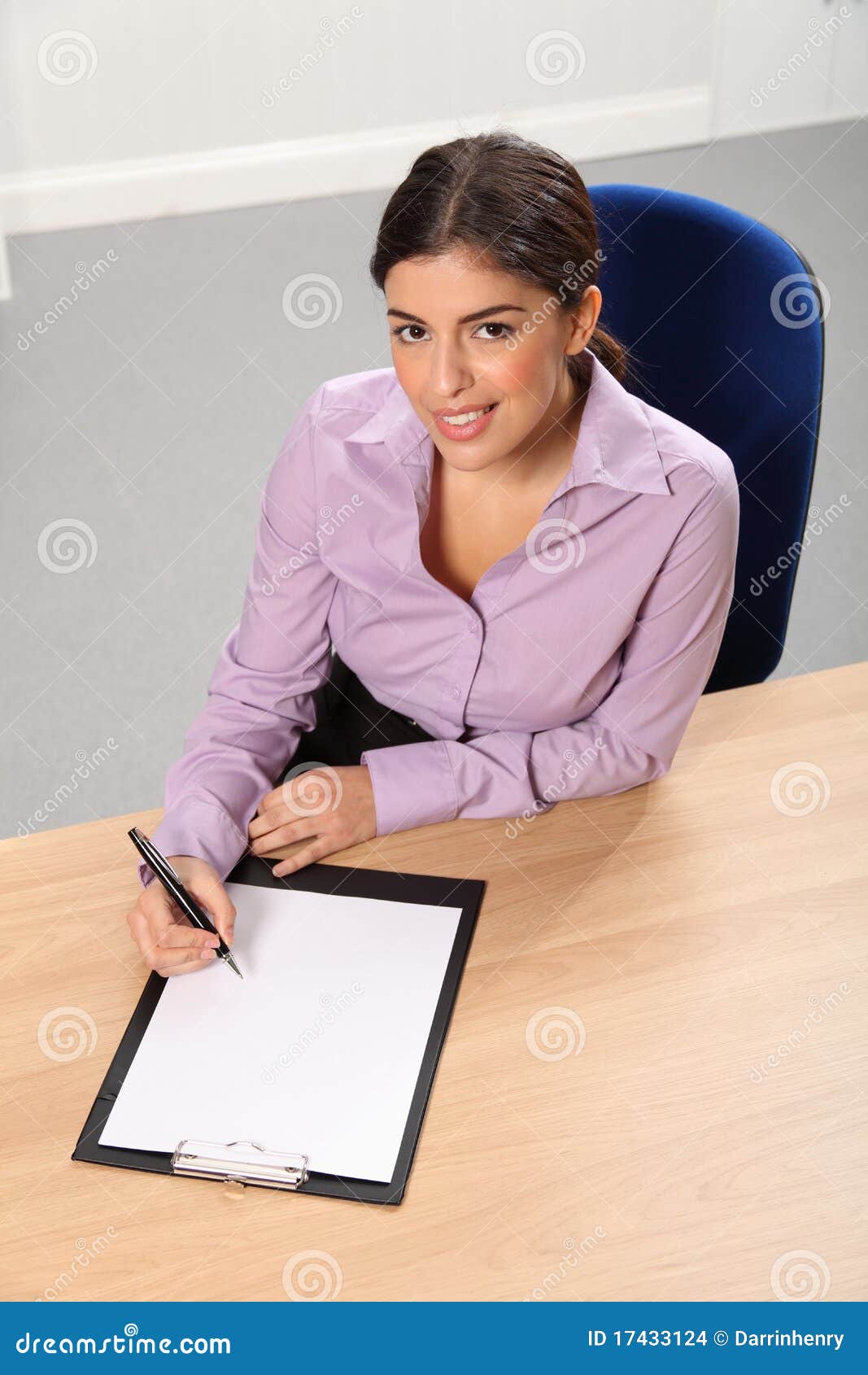 Woman Working in Office Looks Up while Writing Stock Photo - Image of ...