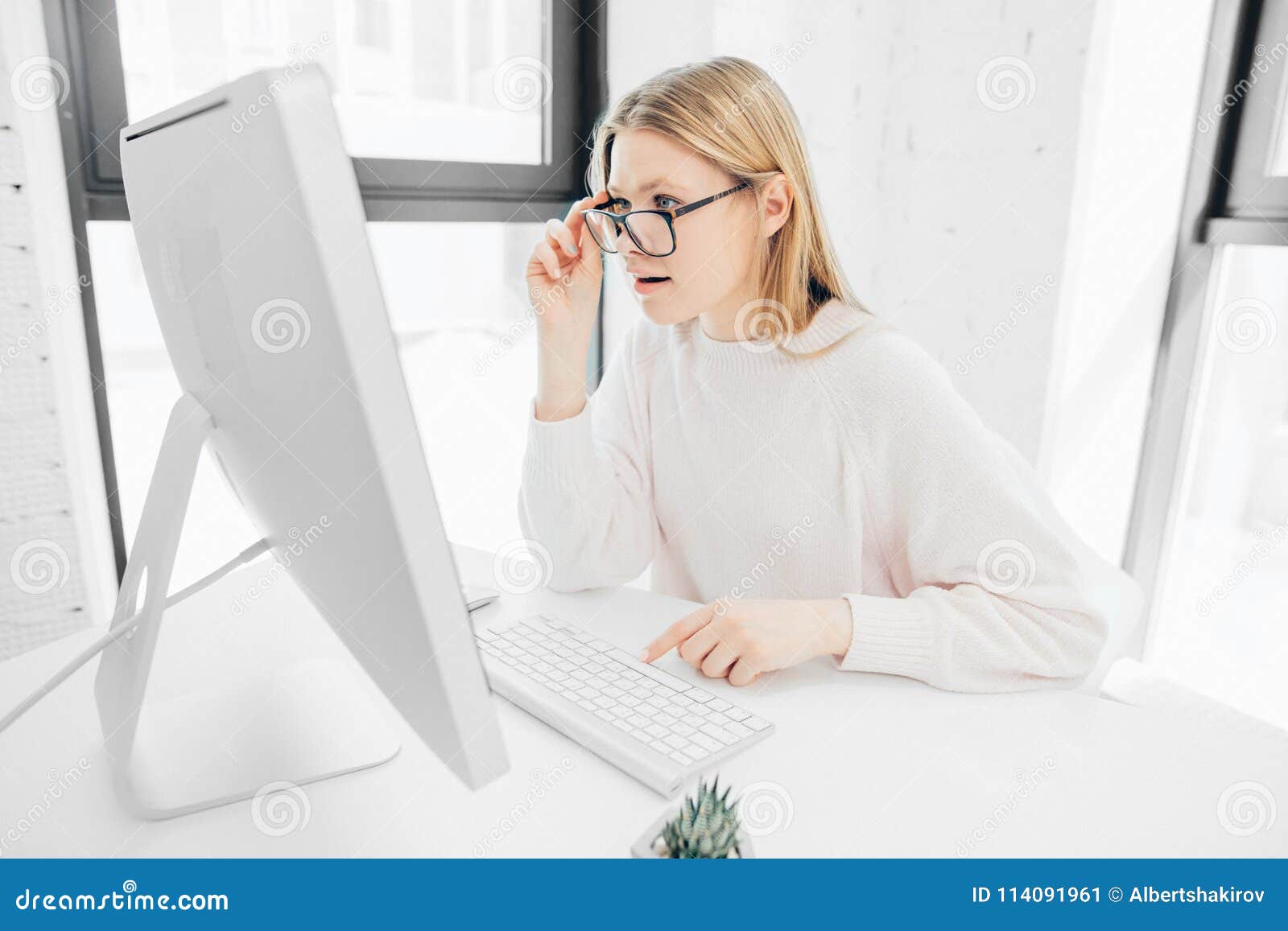 Woman Working in Office, Sitting at Desk, Using Computer and Looking on ...