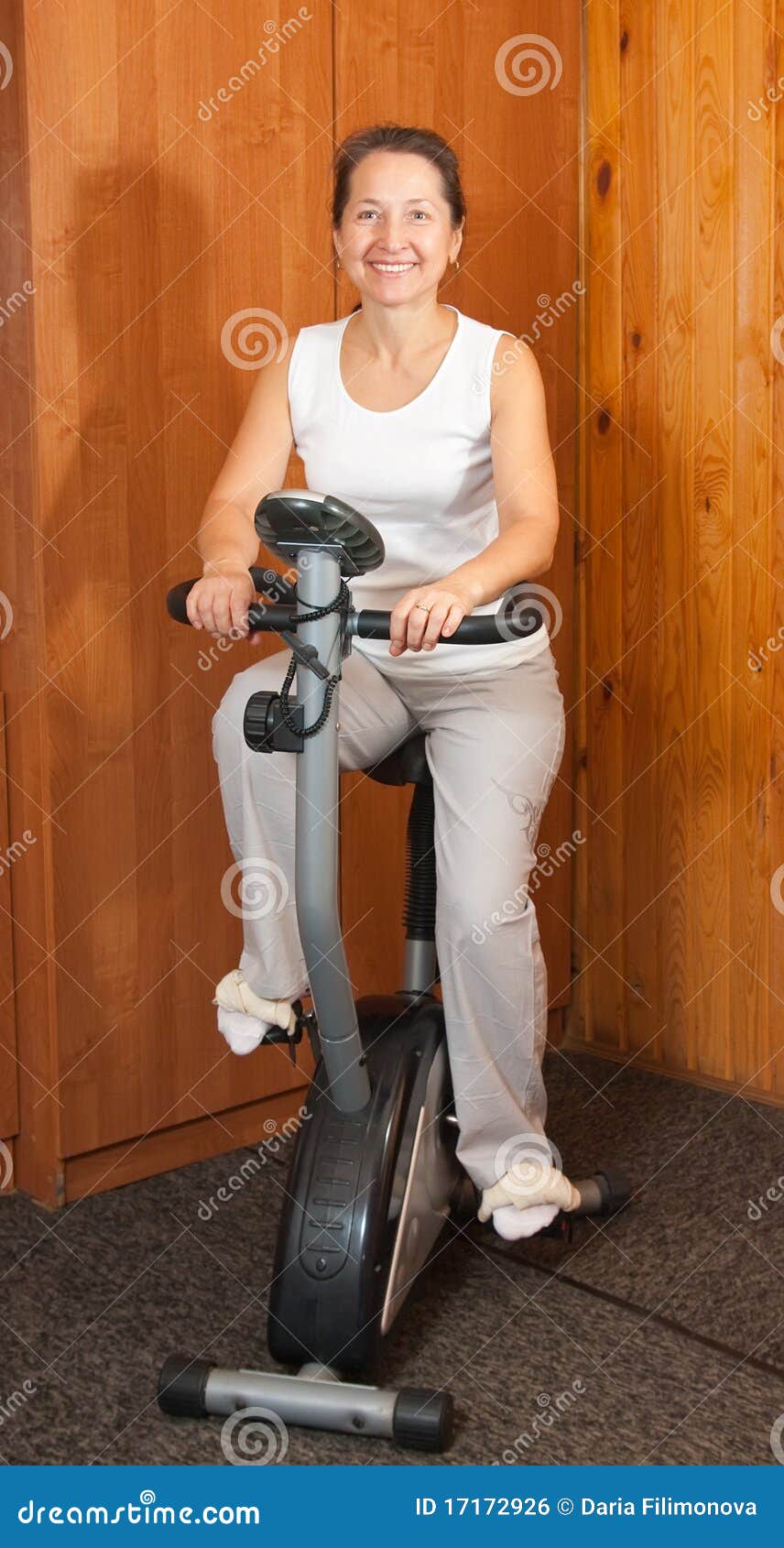 Woman Working Out on Exercycle at Home Stock Photo - Image of exercise ...