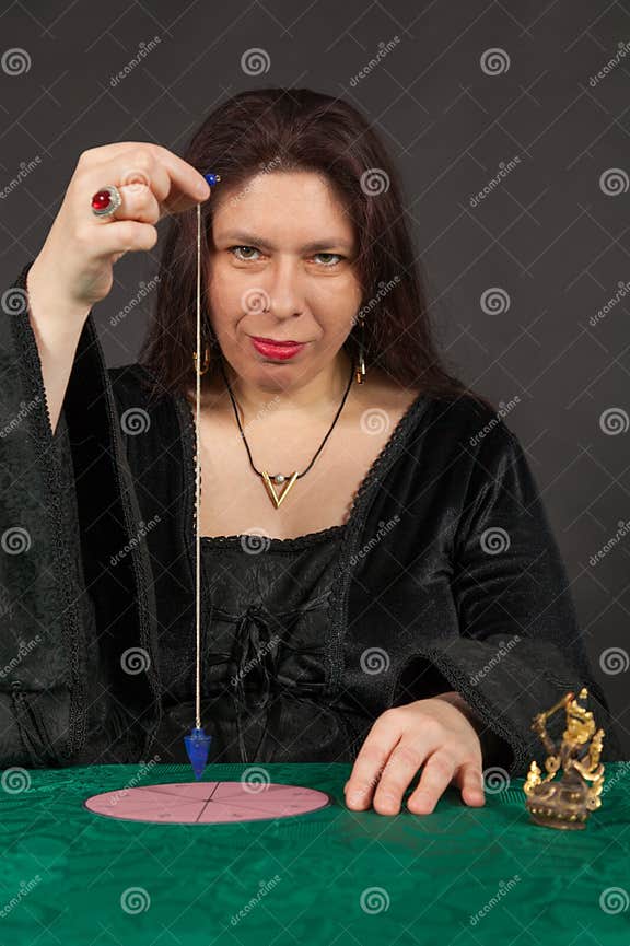 A Woman is Working with a Pendulum Stock Photo - Image of superstition ...