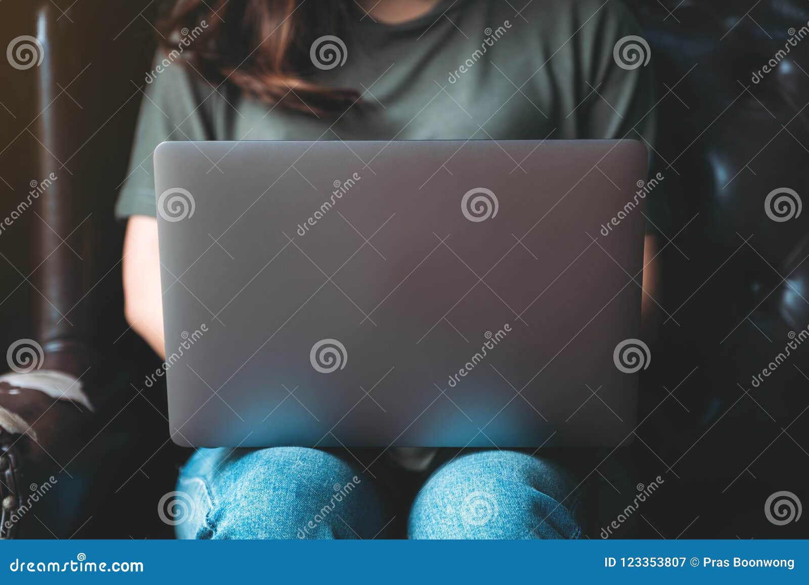 A Woman Working and Typing on Laptop Keyboard while Sitting on Sofa ...