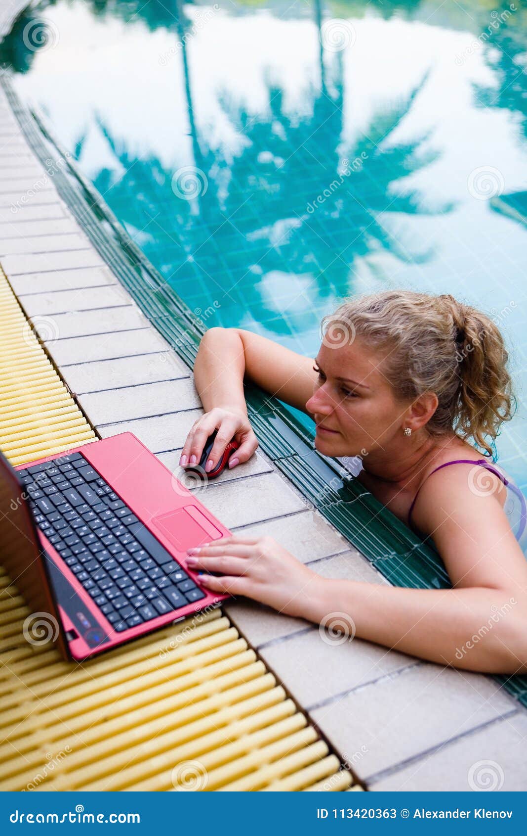 A Woman Works on the Computer in the Pool. Stock Image - Image of game ...
