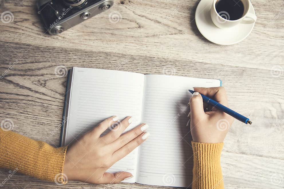 Woman Write in a Notebook with Coffee and Camera on Table Stock Image ...