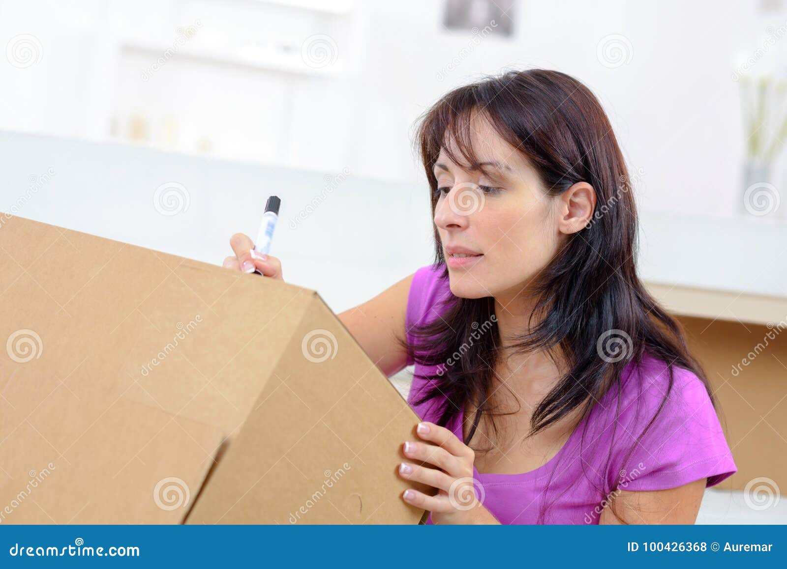 Woman writing on box stock photo. Image of woman, helper - 100426368