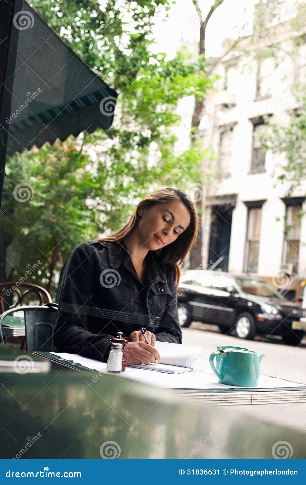 Woman Writing at Cafe stock image. Image of sitting, adult - 31836631