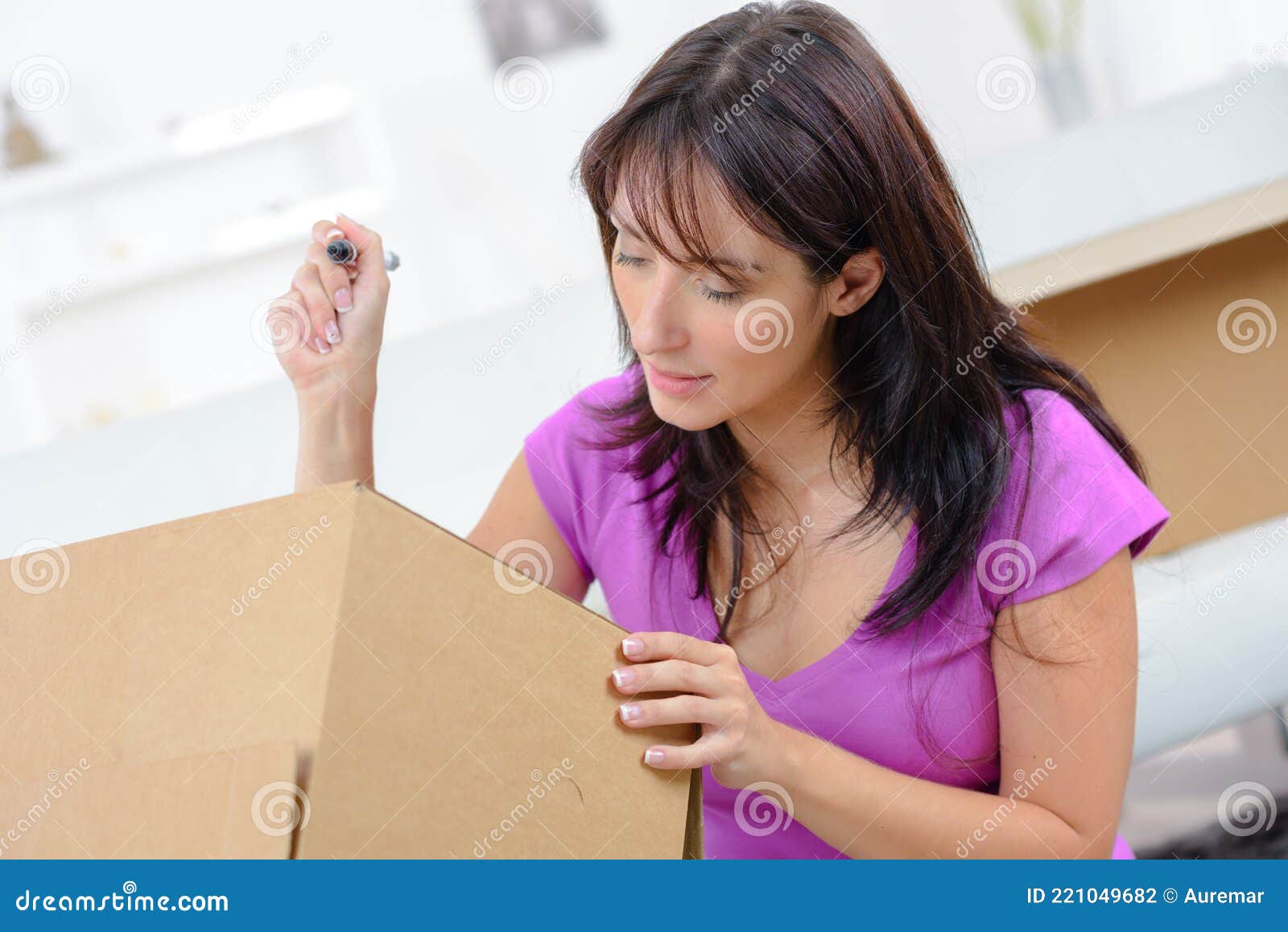 Woman Writing on Cardboard Box at Table Stock Photo - Image of table ...
