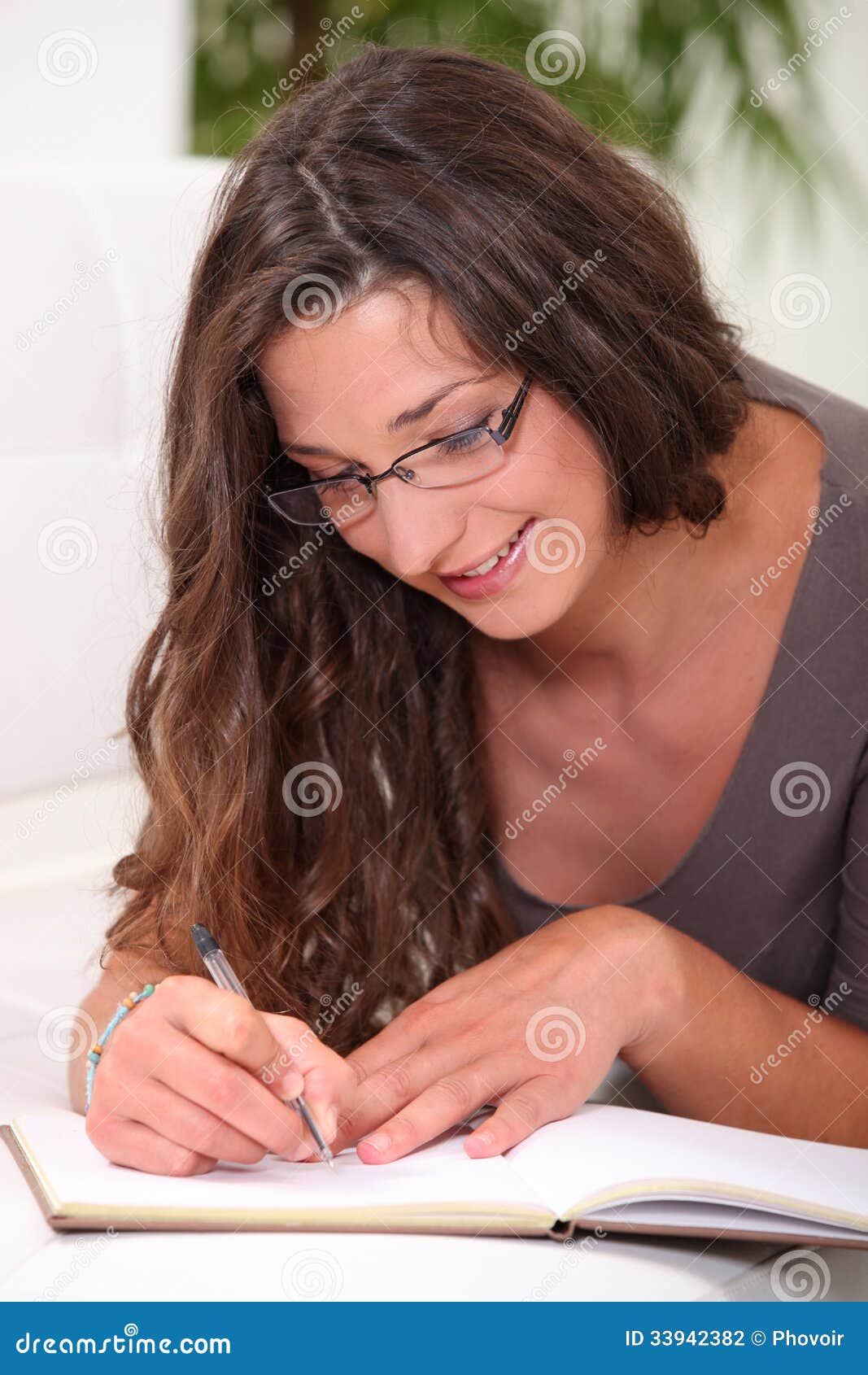 Woman writing in her diary stock photo. Image of eyeglasses - 33942382
