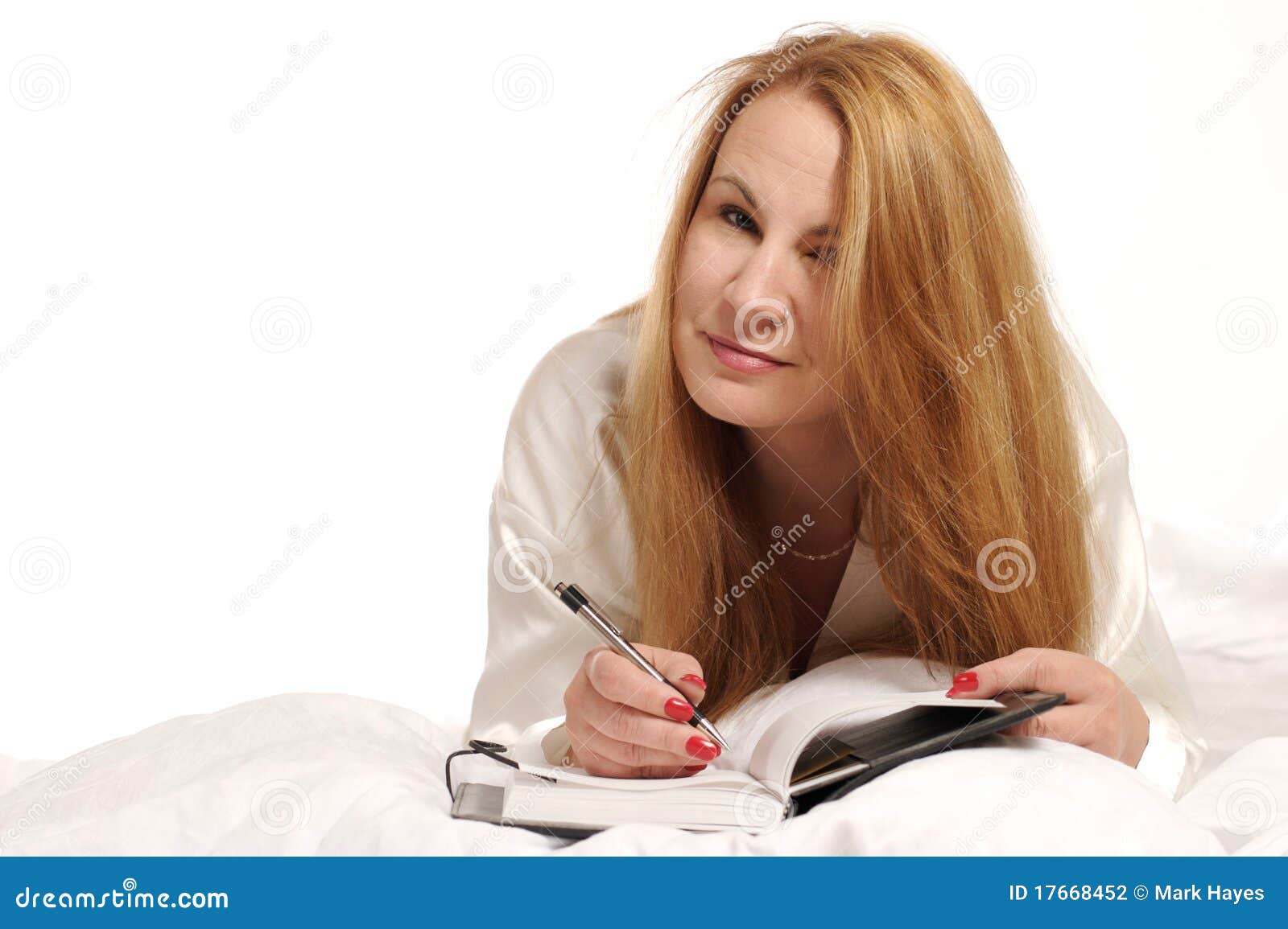 Woman writing in journal stock photo. Image of woman - 17668452