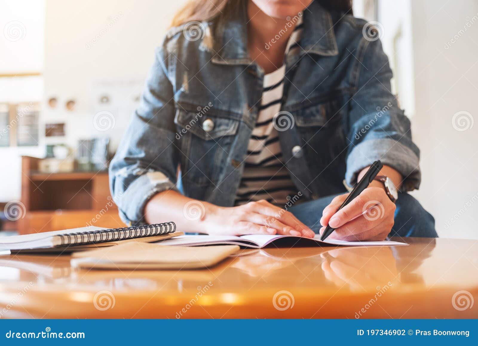 A Woman Writing on a Notebook on the Table Stock Photo - Image of ...