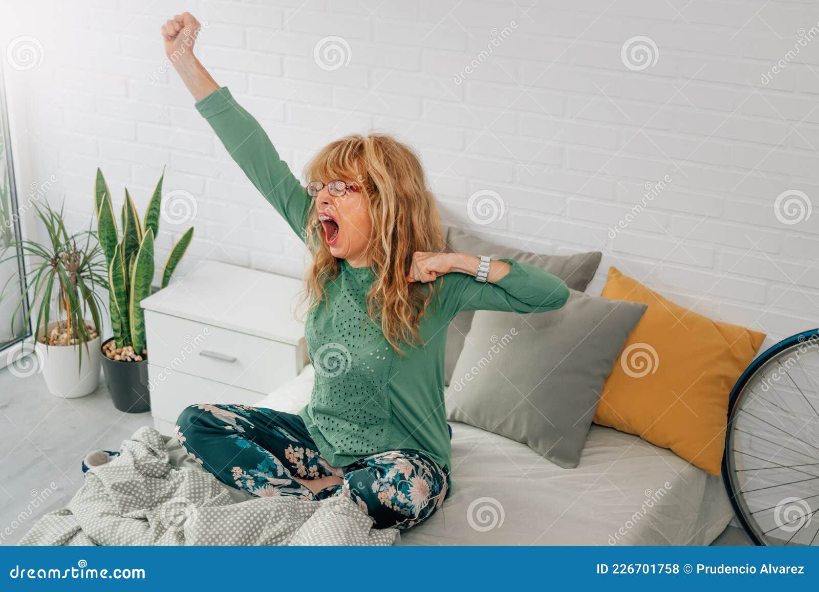 Woman yawning in bedroom stock photo. Image of lying - 226701758