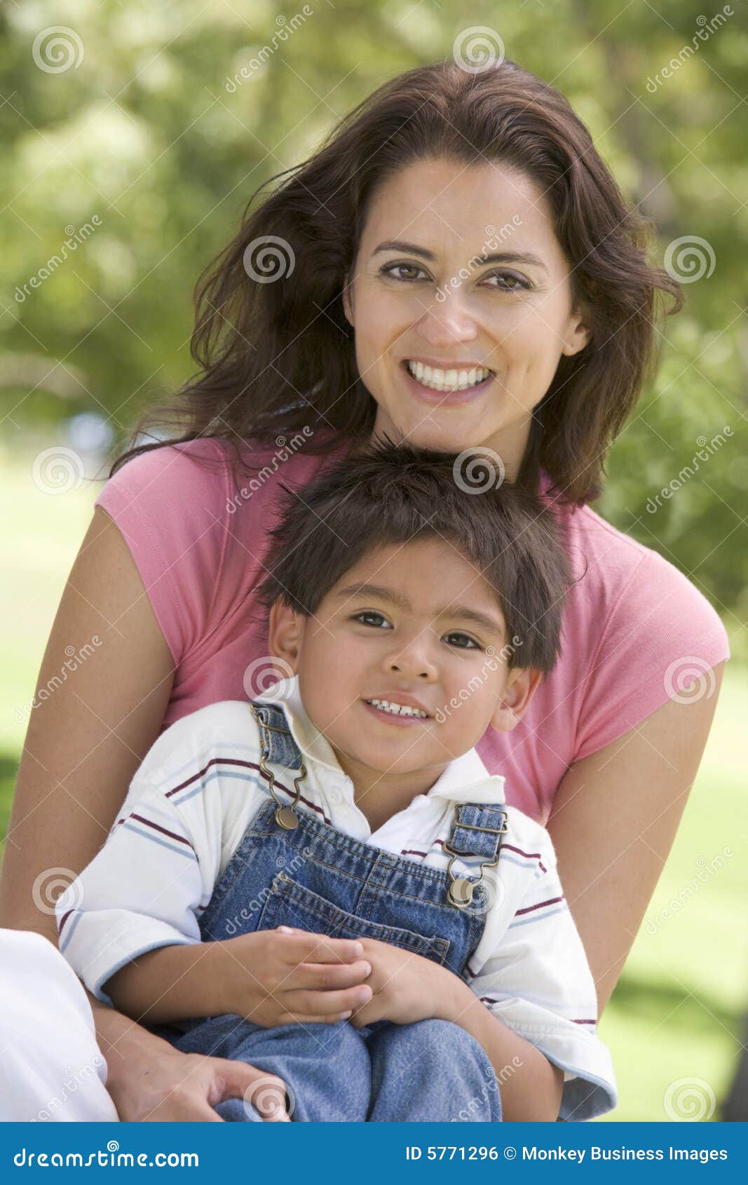 Woman and Young Boy Sitting Outdoors Smiling Stock Photo - Image of ...